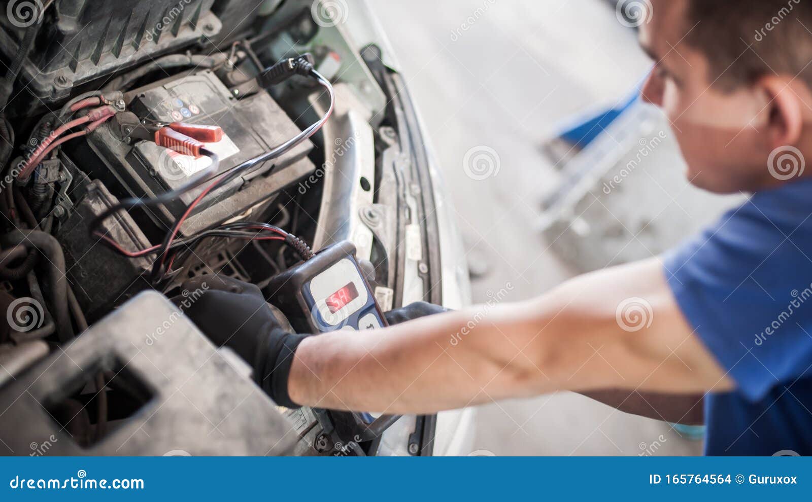 Car Mechanic Checking and Testing Automotive Accumulator with Battery ...