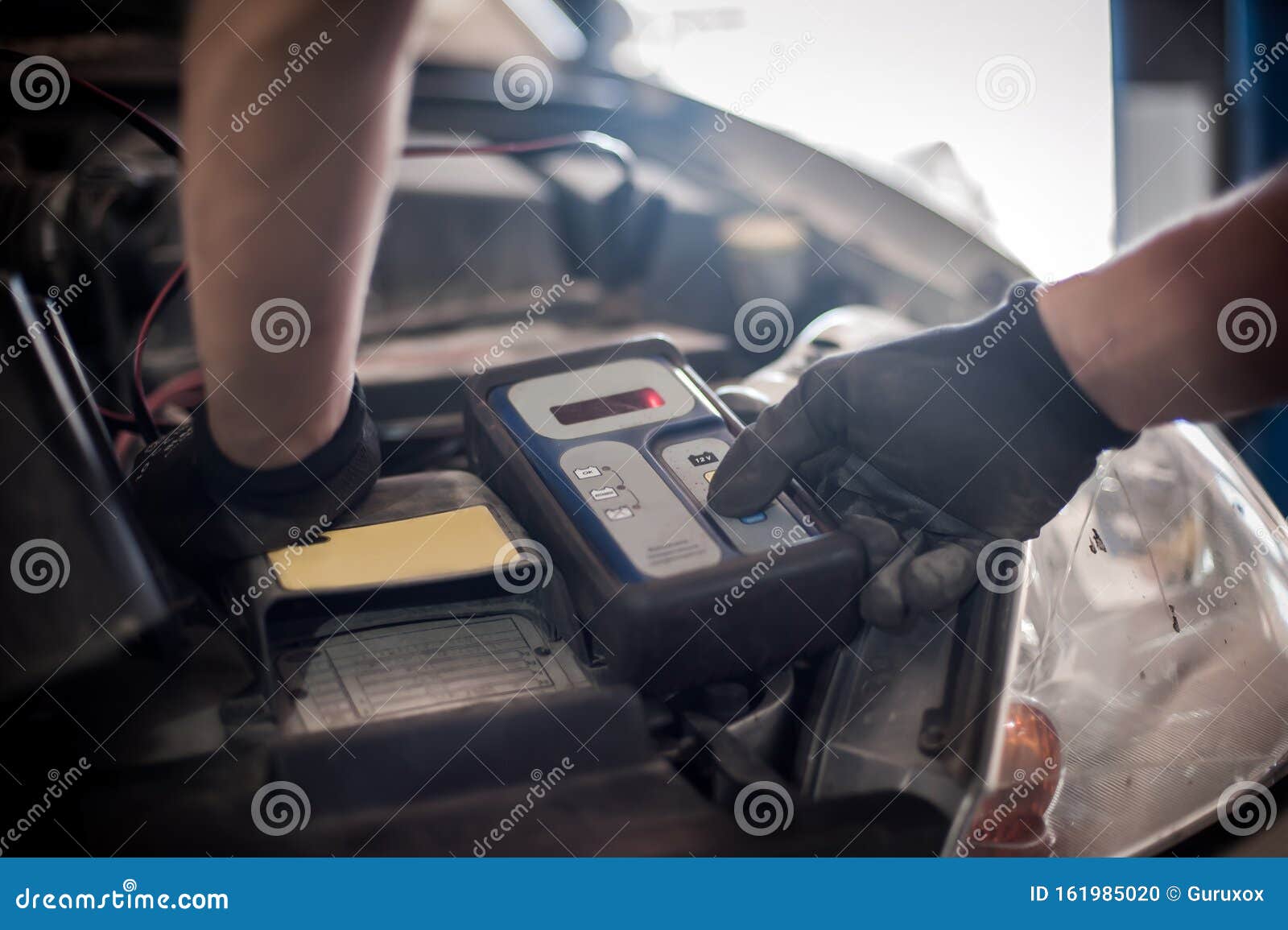 Car Mechanic Checking and Testing Automotive Accumulator with Battery ...