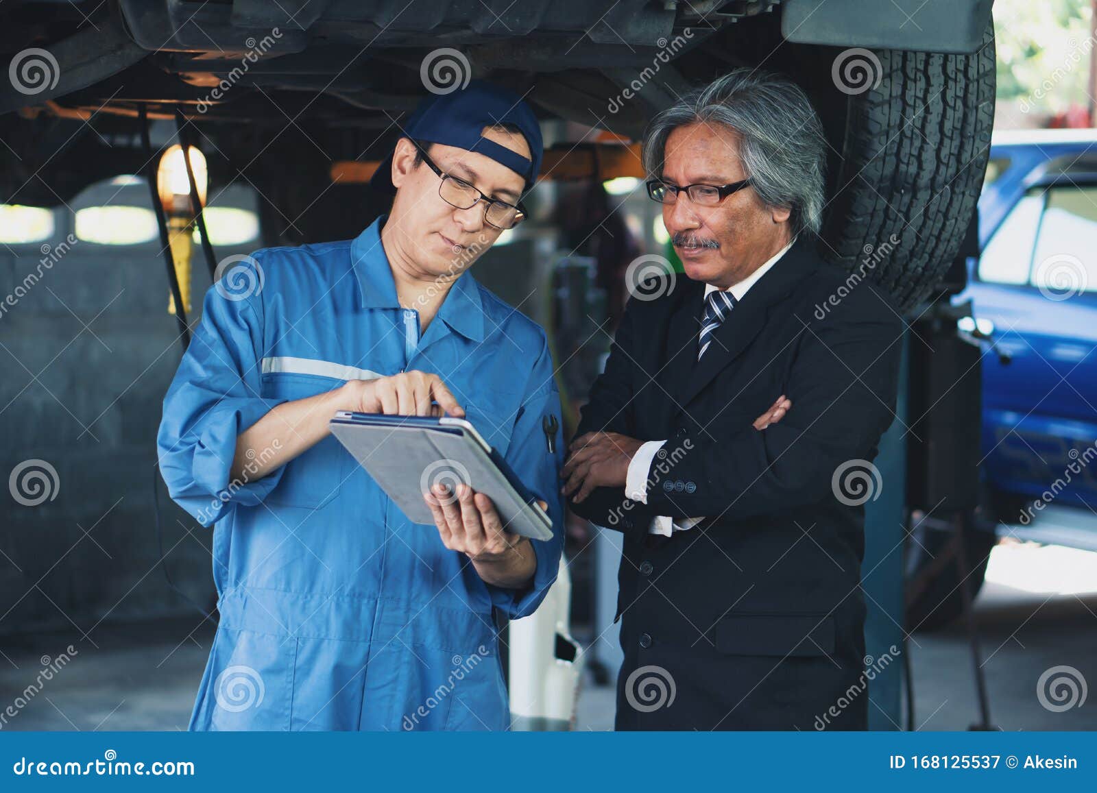 Car Mechanic Explaining Customer about What Have Been Done for Car ...