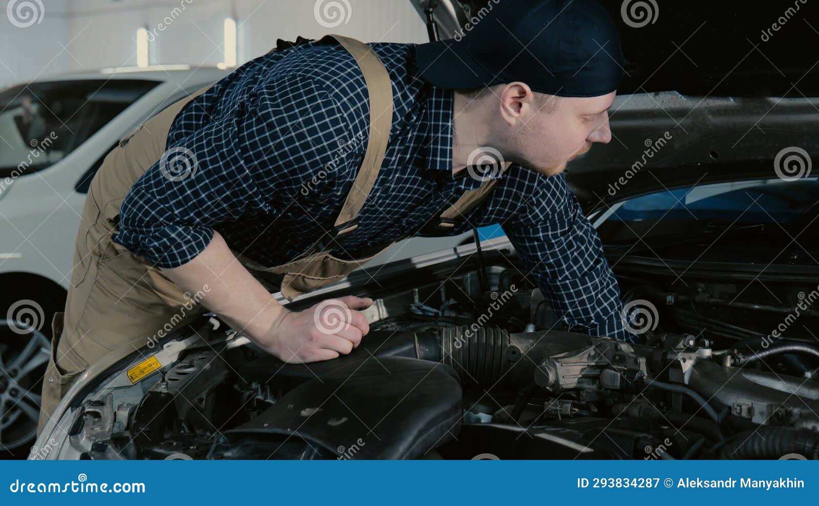 A Car Mechanic Repairs a Car. the Mechanic is Looking for a Malfunction ...