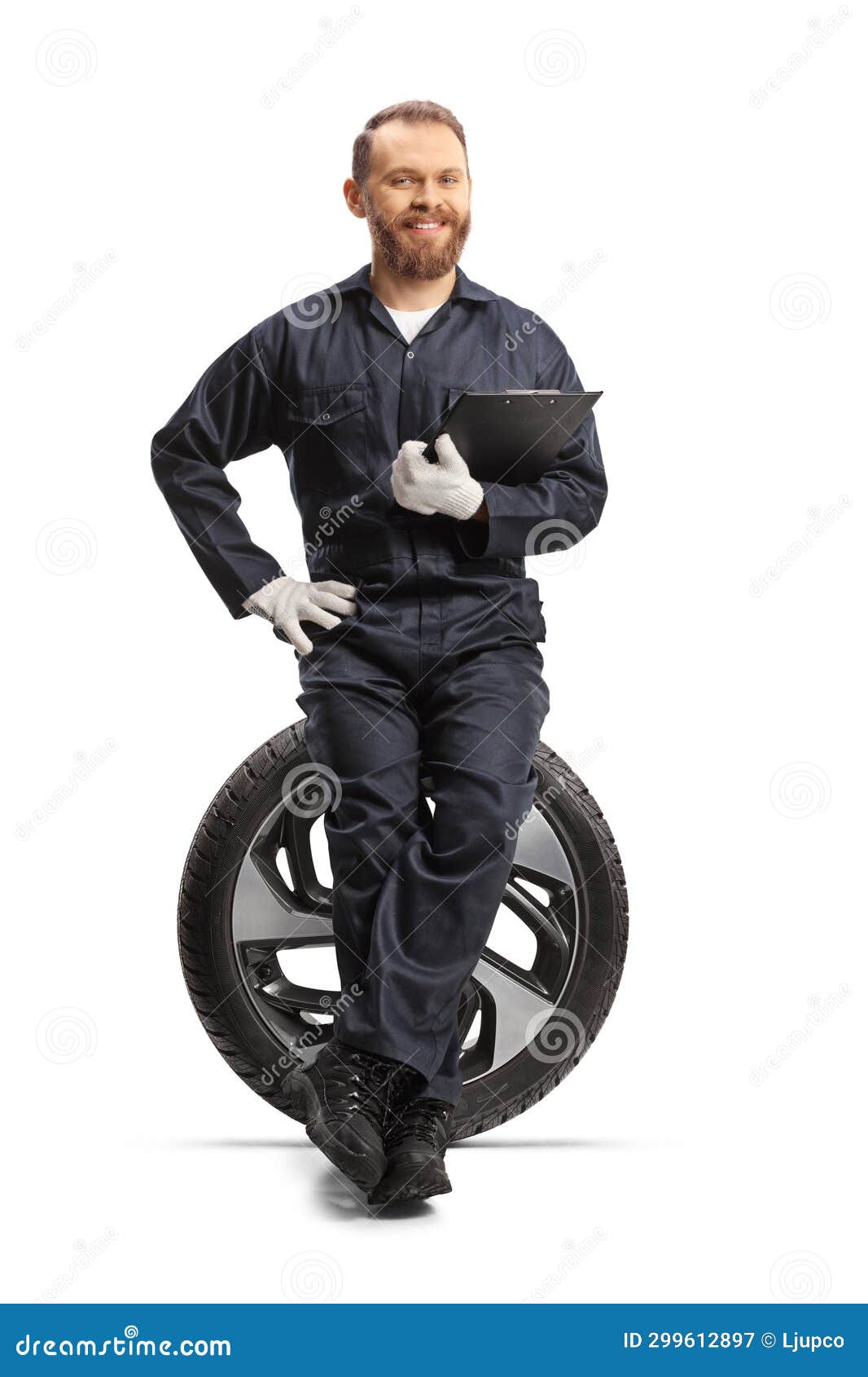 Car Mechanic Smiling and Sitting on a Tire with Document in Hands Stock ...