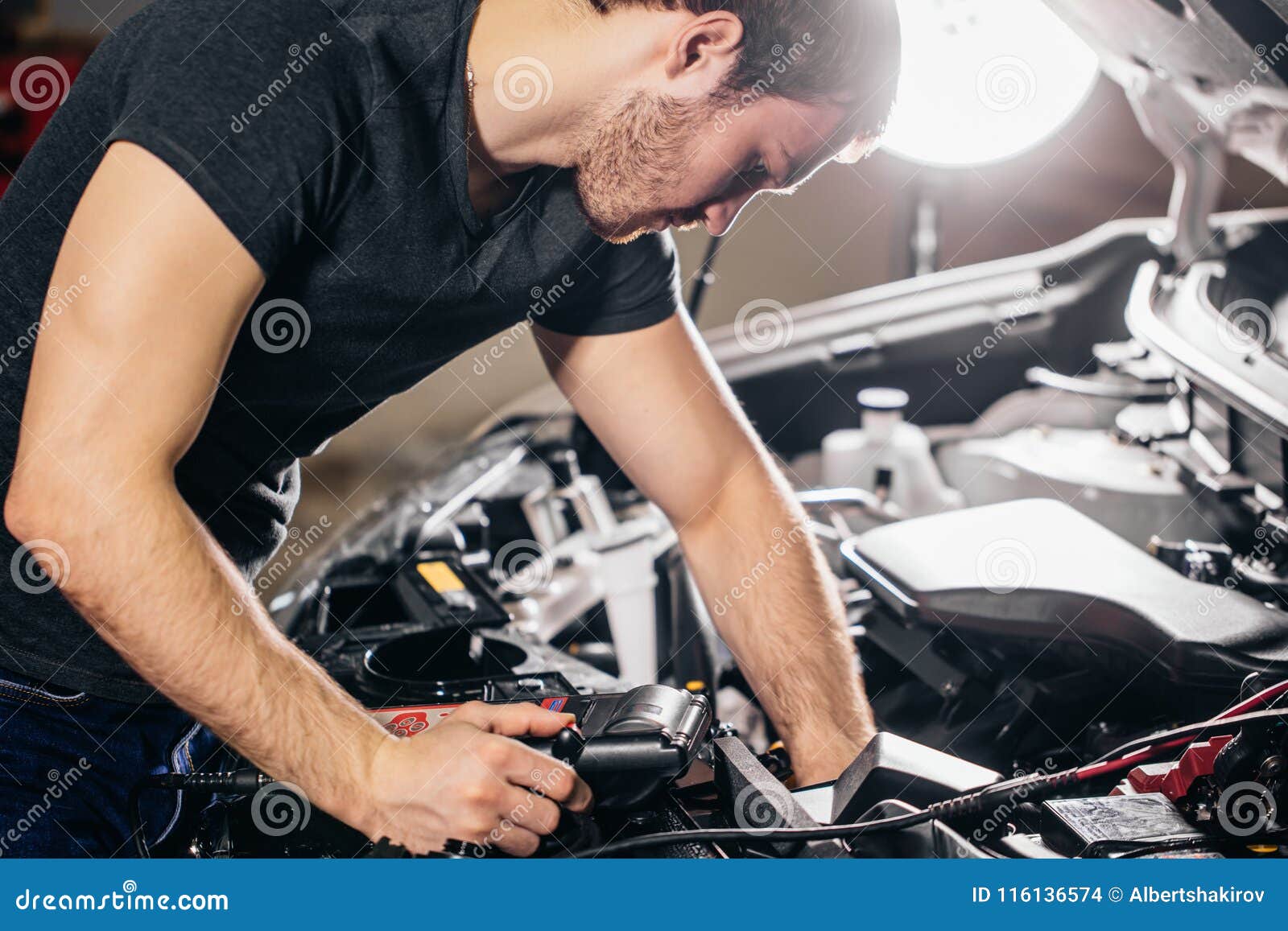 Mechanic Testing Electrical System on Automobile Stock Photo - Image of ...
