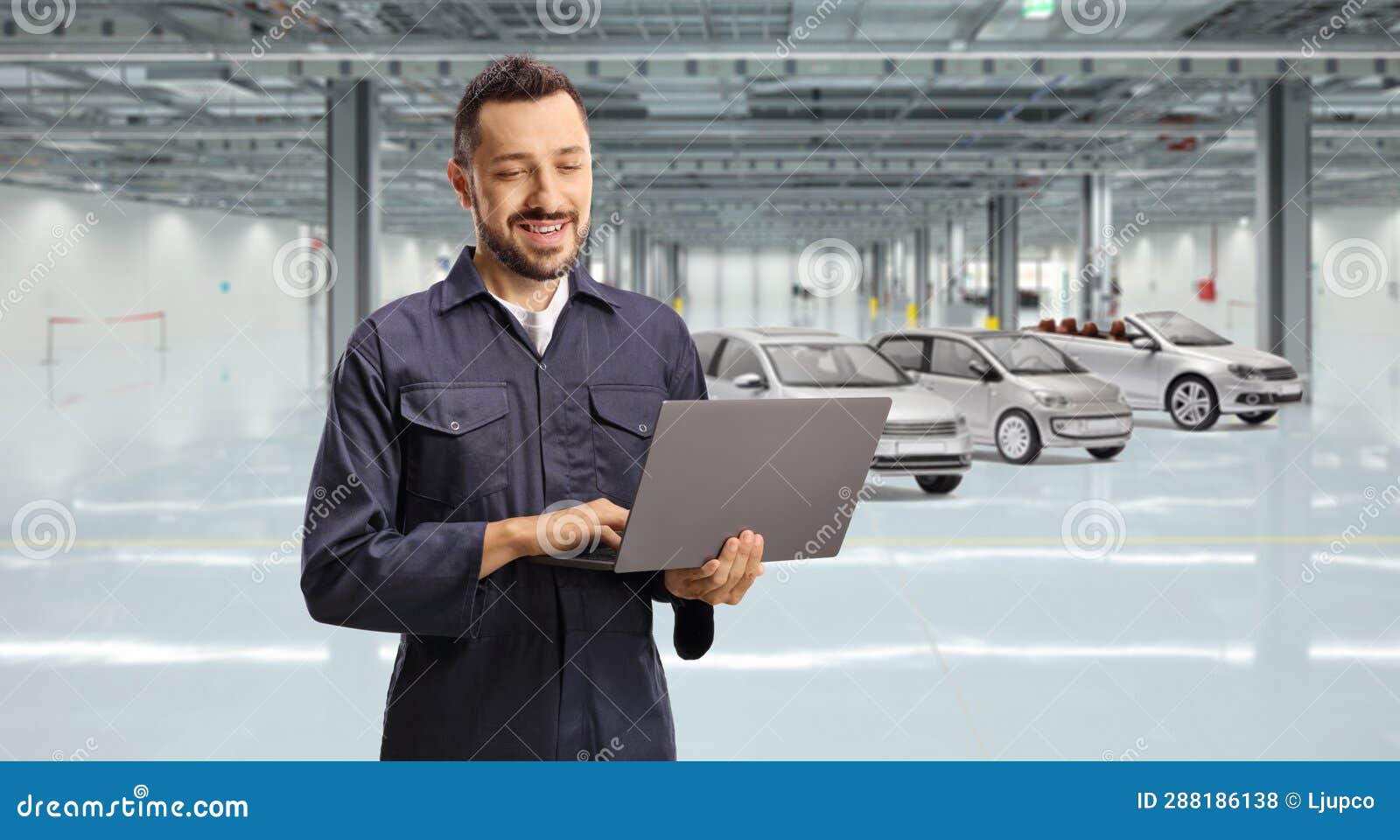 Car Mechanic Using a Laptop Computer in a Garage Stock Photo - Image of ...