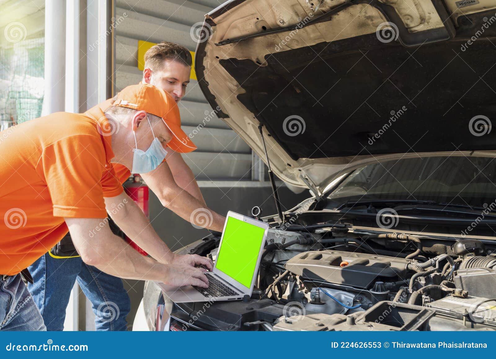 A Car Mechanic is Using a Laptop Computer To Check the Engine Operation ...