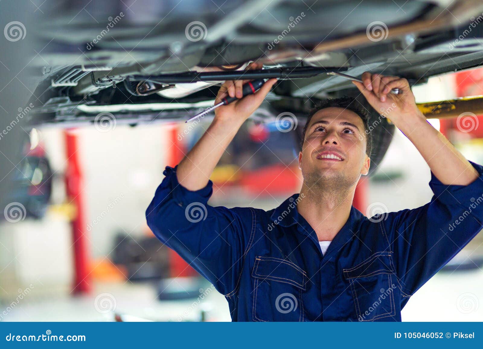 Car Mechanic Working on the Underside of a Car Stock Photo - Image of ...