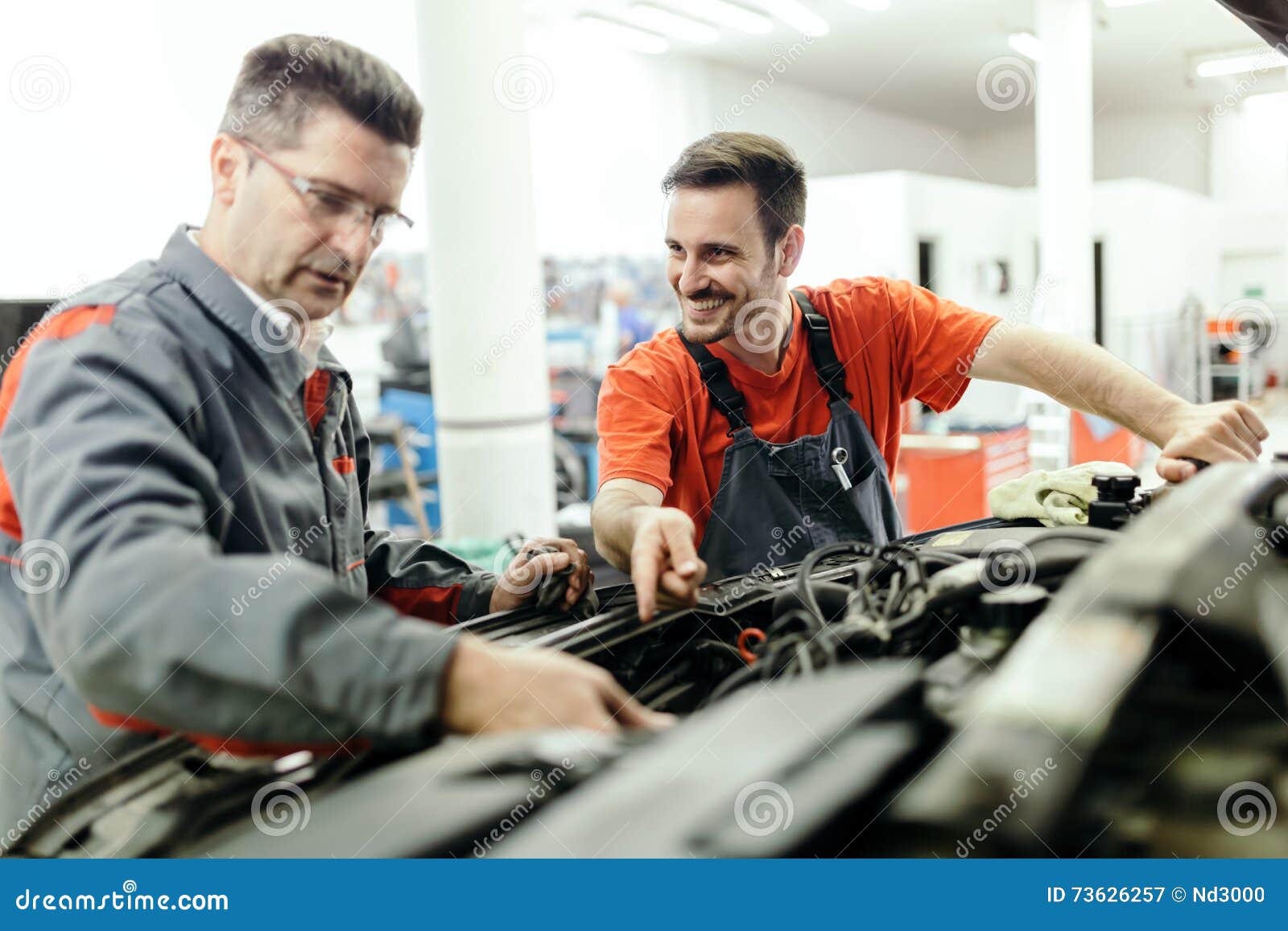 Car mechanics fixing car stock image. Image of hood, engineers - 73626257