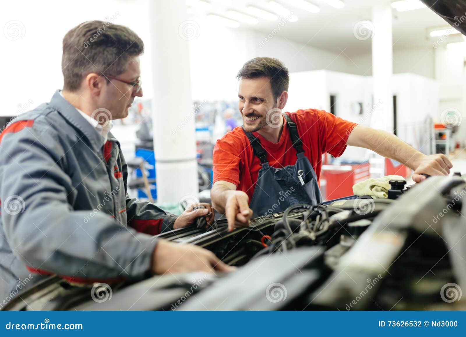Car mechanics fixing car stock photo. Image of occupation - 73626532
