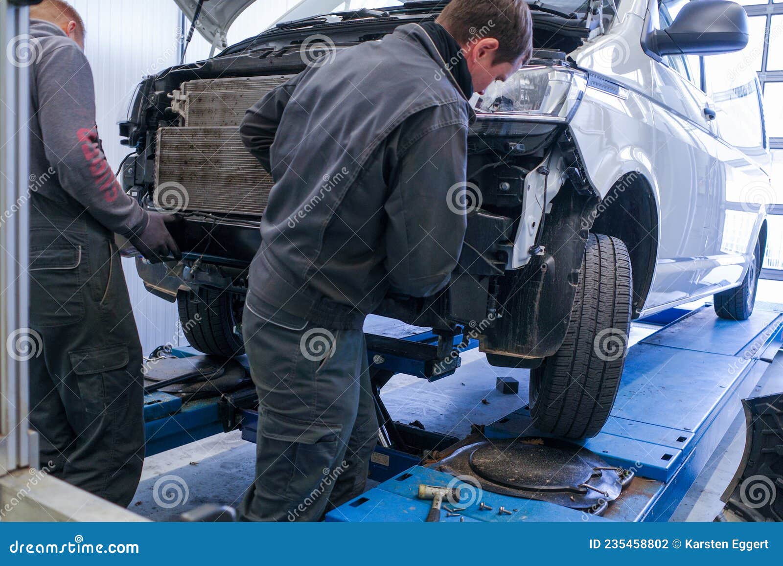 2 Car Mechanics Repairing the Front of a Car in a Workshop Editorial ...