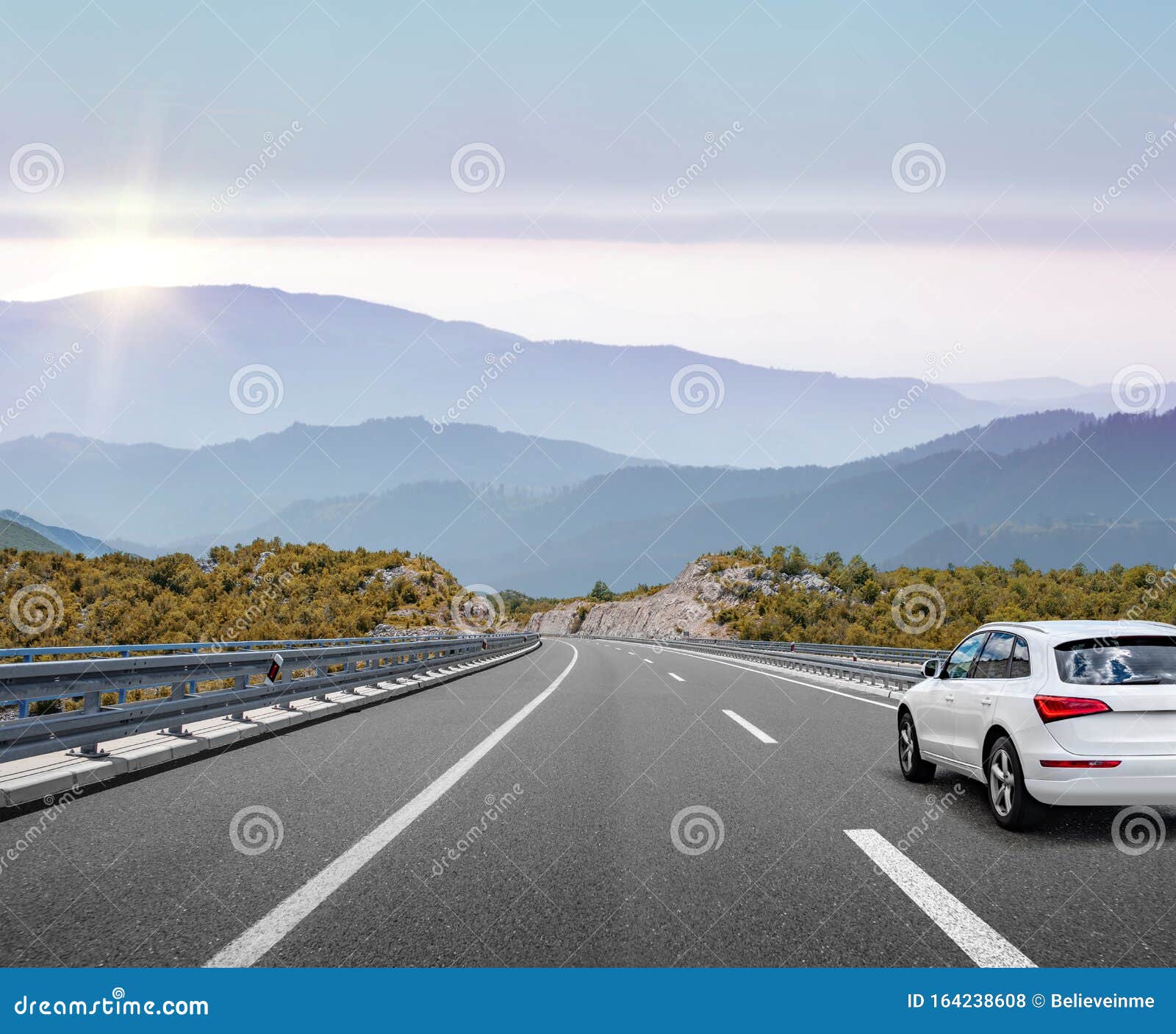 Car Moves on the Road among the Mountains and Forests. Stock Photo ...