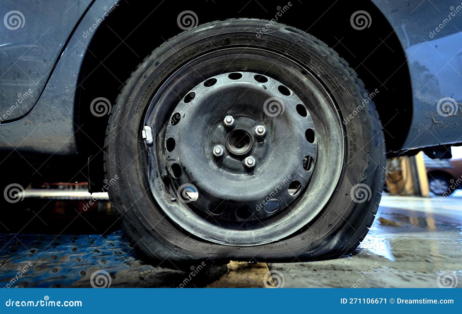 Car with a Punctured and Broken Wheel in a Car Repair Shop Stock Image ...