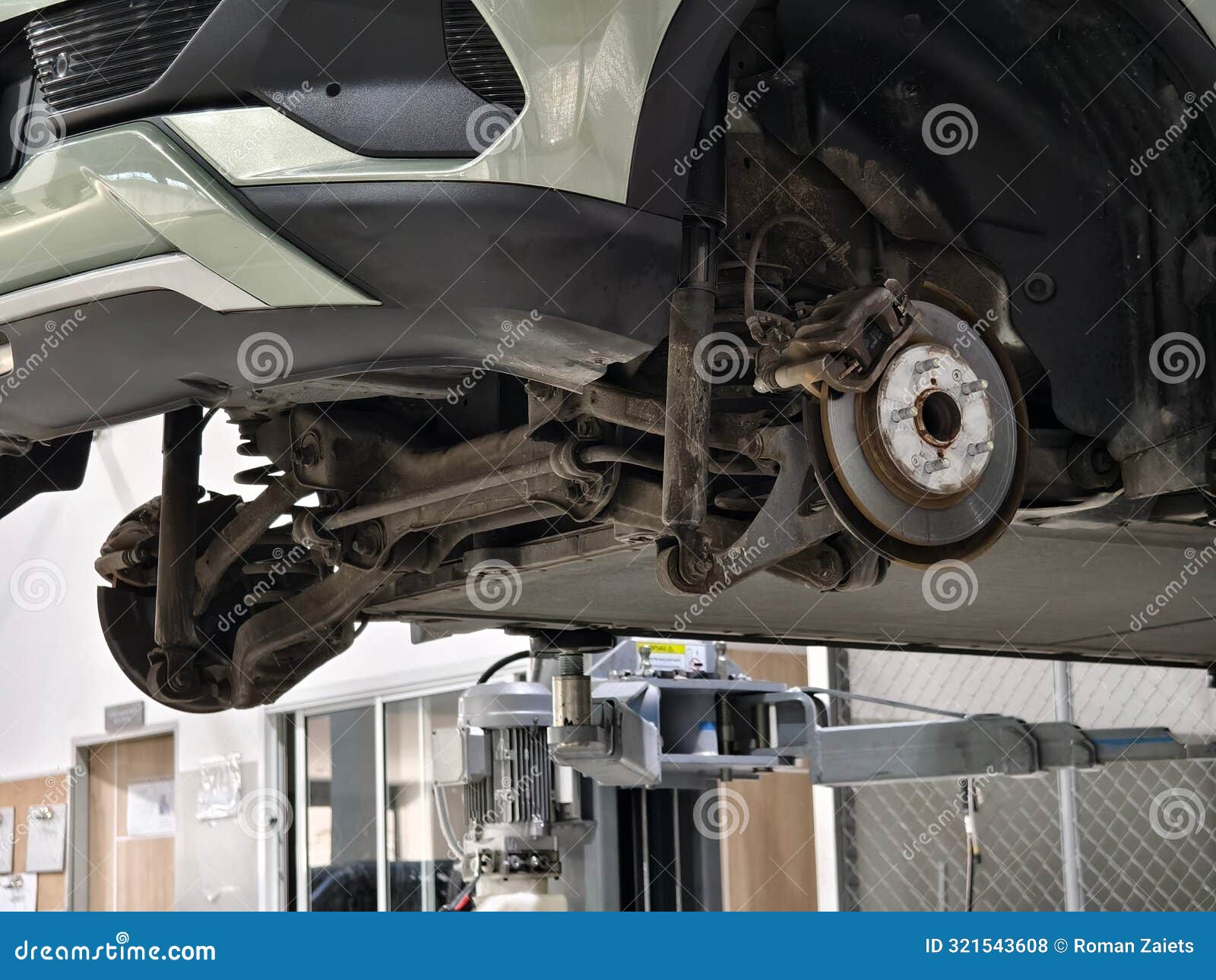 A Car is Raised Up Using a Lift Inside a Service for Maintenance Stock ...
