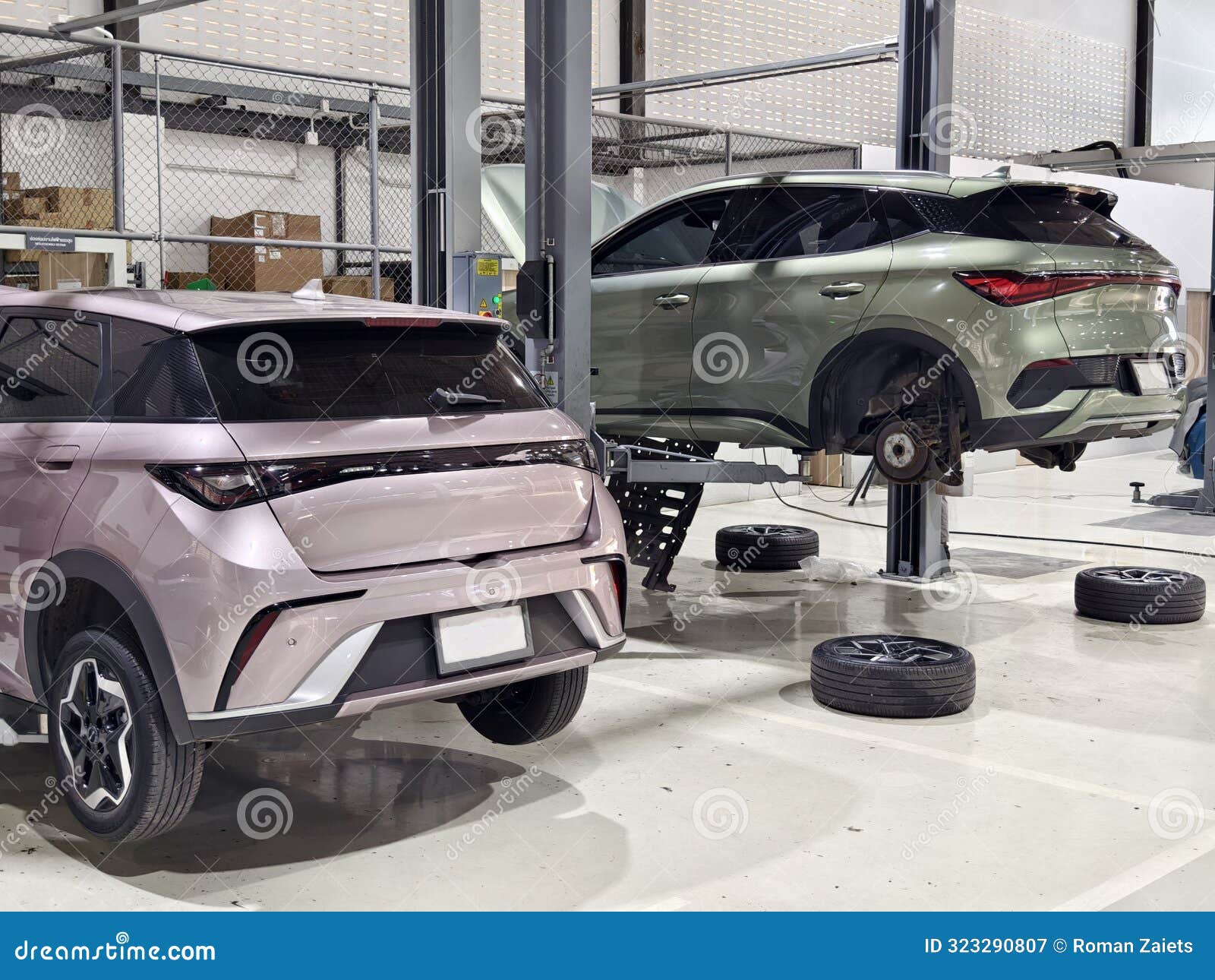 A Car is Raised Up Using a Lift Inside a Service for Maintenance Stock ...