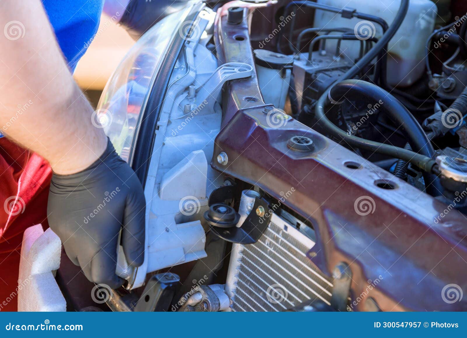 During a Car Repair, Mechanic Assembles Headlights of Vehicle Stock ...