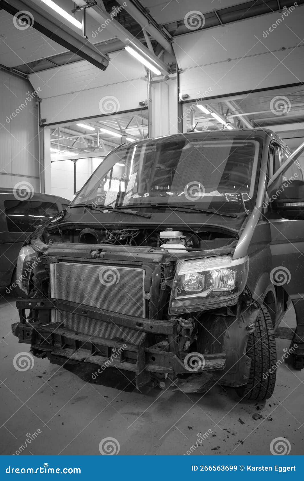 In a Car Repair Shop There is a Van Whose Front Was Severely Damaged by ...