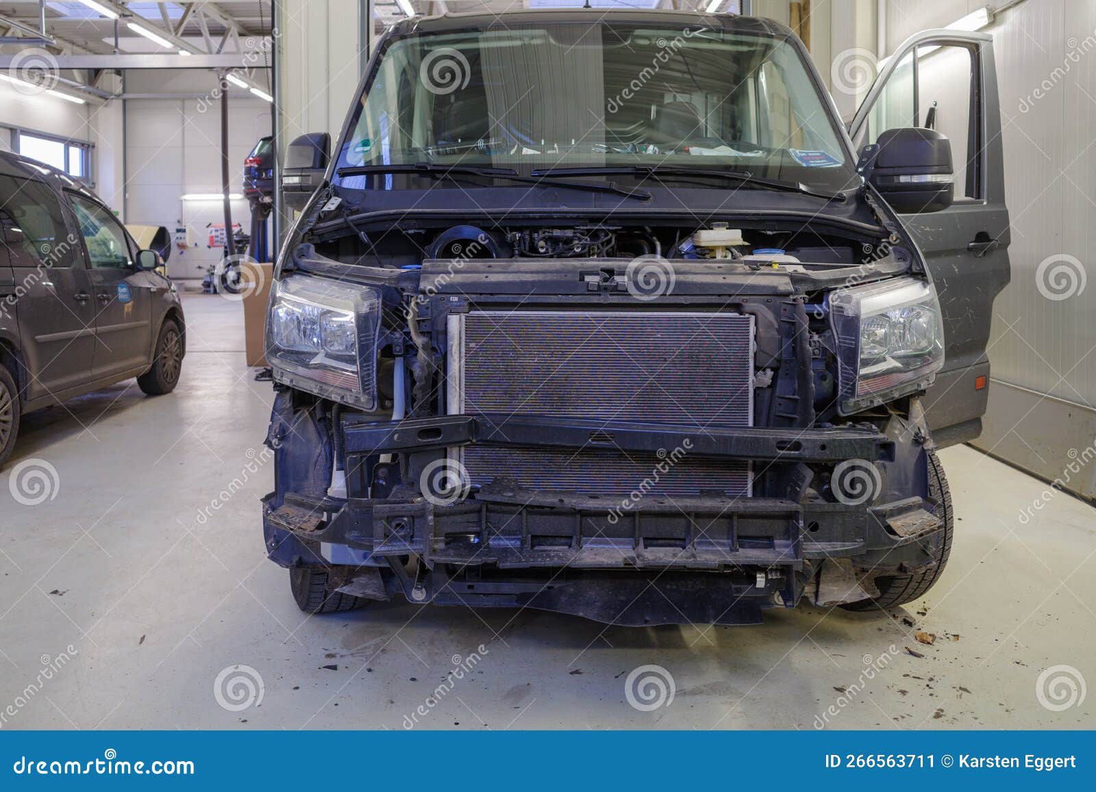 In a Car Repair Shop There is a Van Whose Front Was Severely Damaged by ...