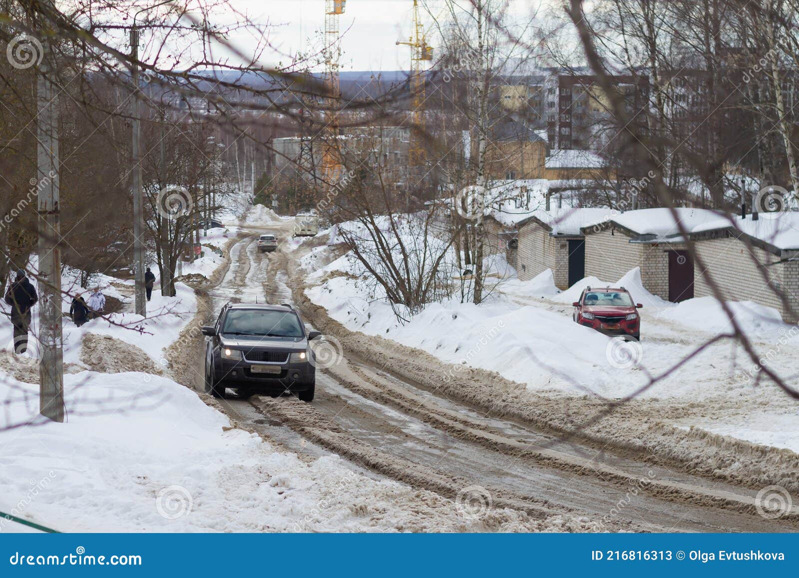 The Car Rides on a Road with Melted Snow and Ruts from the Wheels in ...