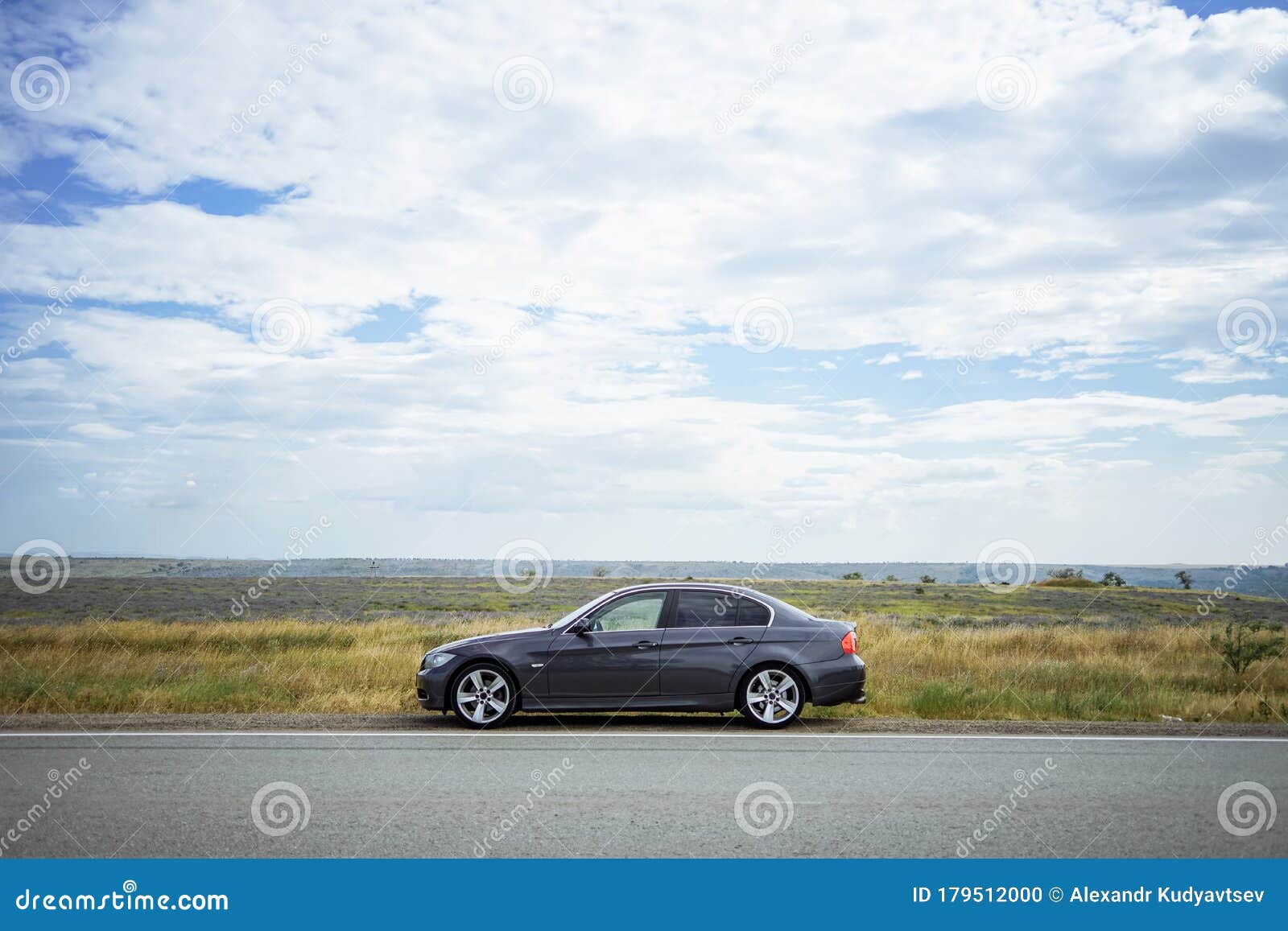 Car on the Road on the Background of a Field Stock Photo - Image of ...