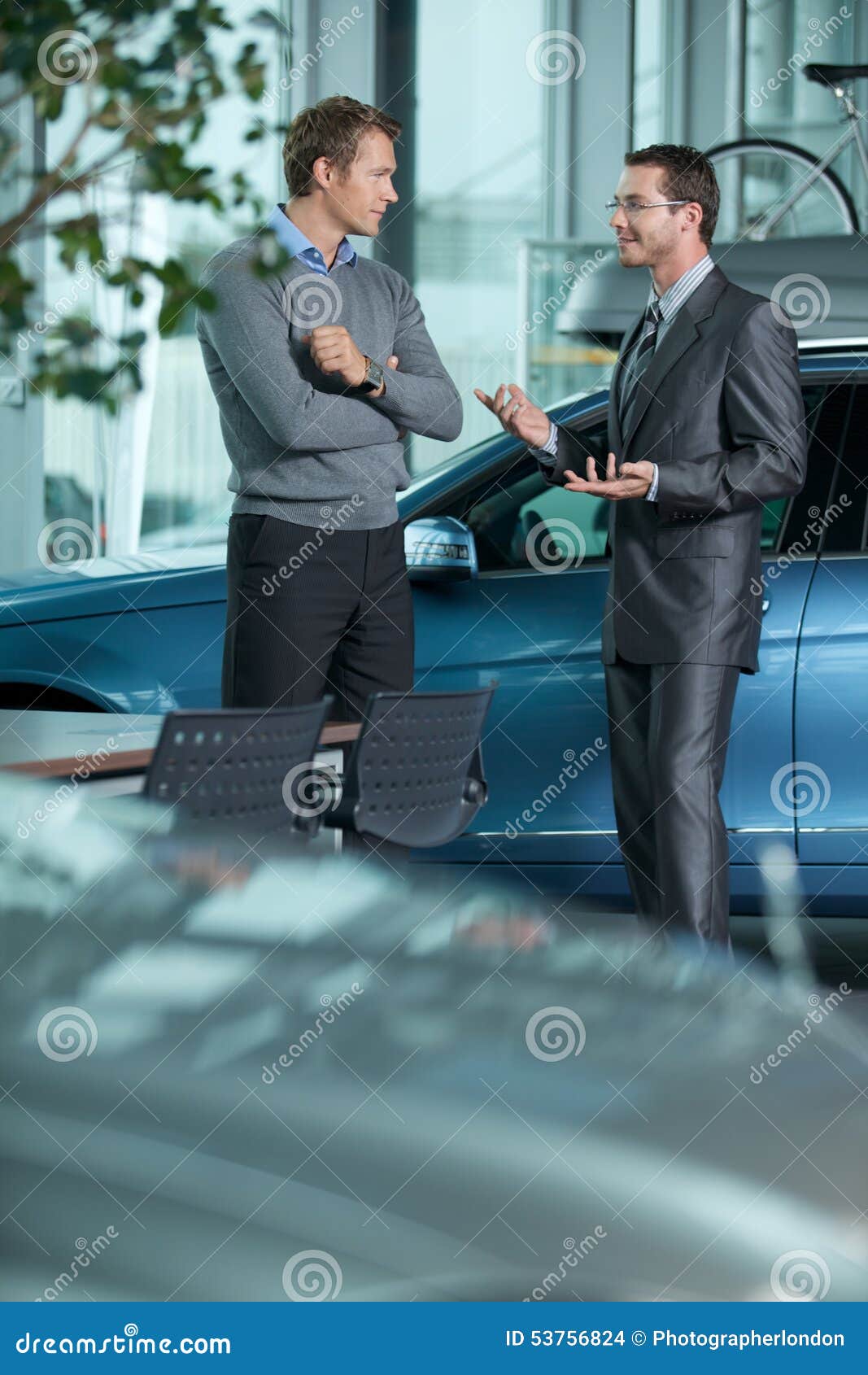 Car Salesperson Explaining Car Features To Customer Stock Photo - Image ...
