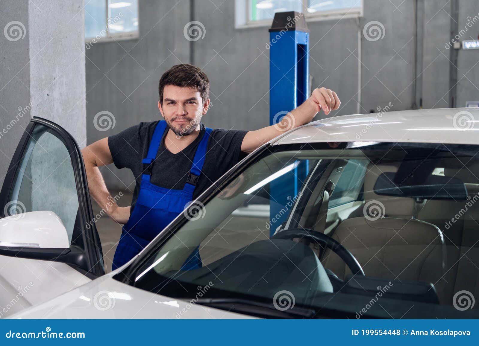 A Car Service Worker is Standing Next To a White Car Stock Photo ...