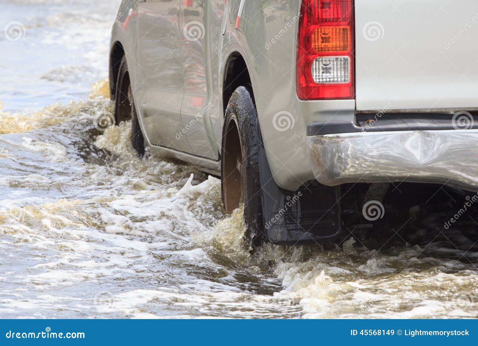 Car Splashes through a Large Puddle on a Flooded Stock Image - Image of ...