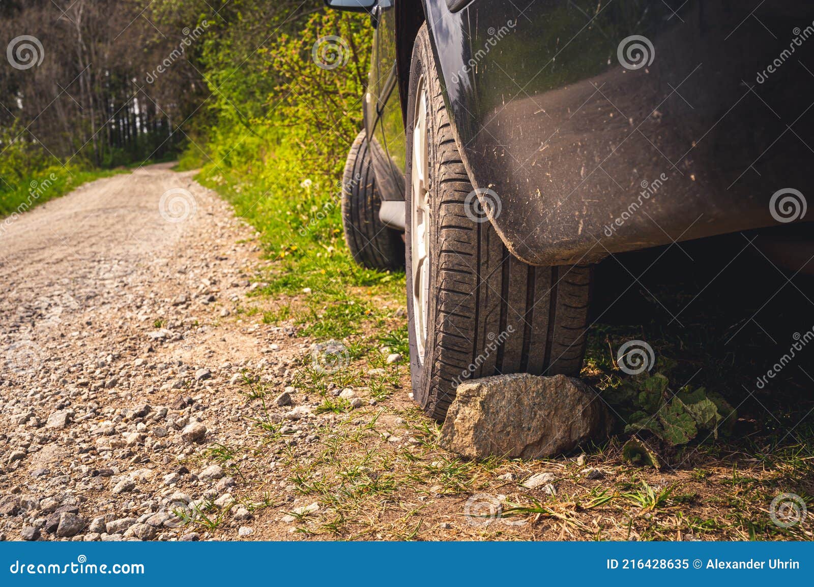 Car Supported Against Shifting by Rock in Steep Hill. Stock Image ...