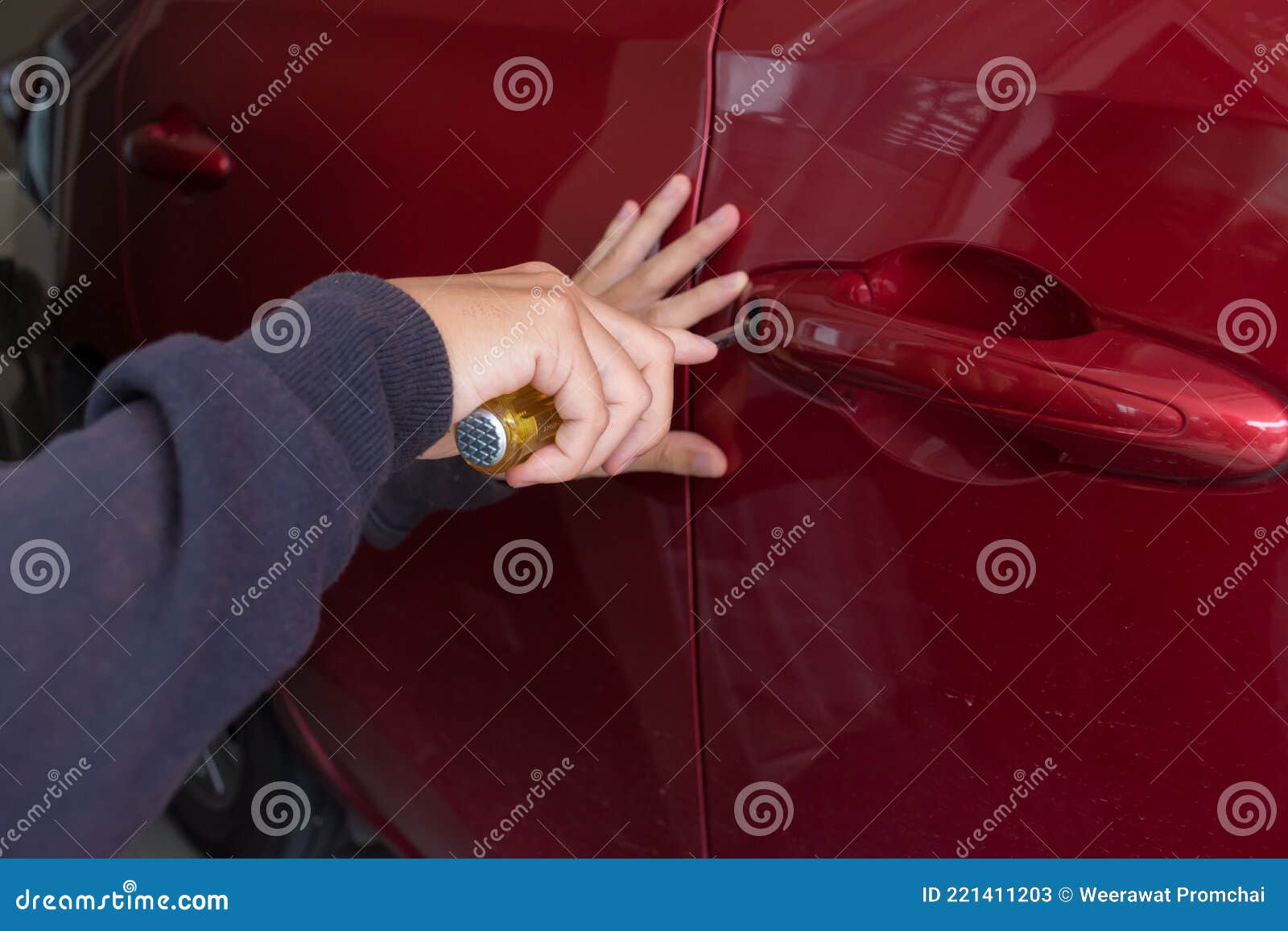 Car thief stealing a car. stock image. Image of hand - 221411203
