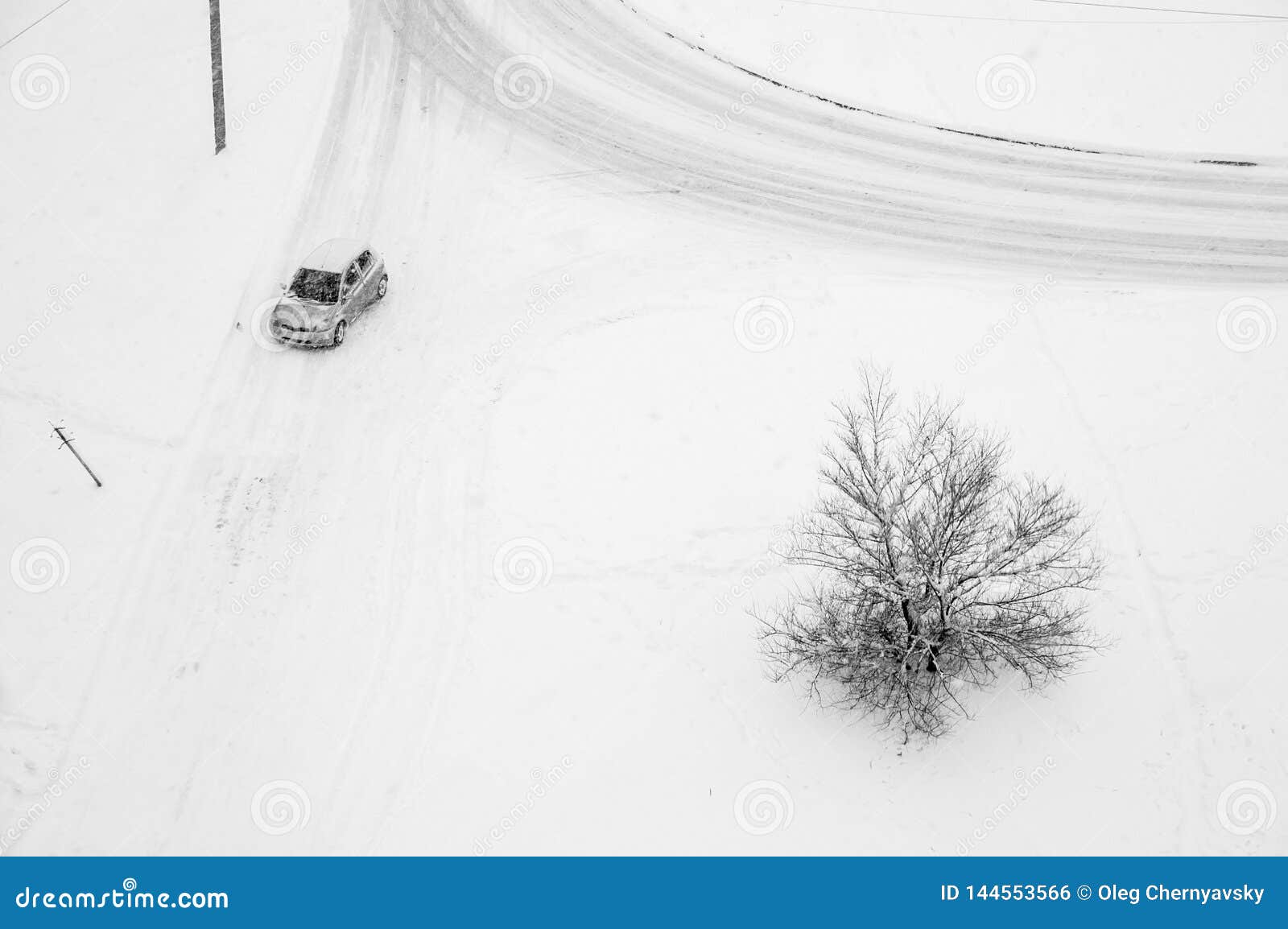 Car Turns on Snowy Turn of the Road in Winter during Snowfall Stock ...