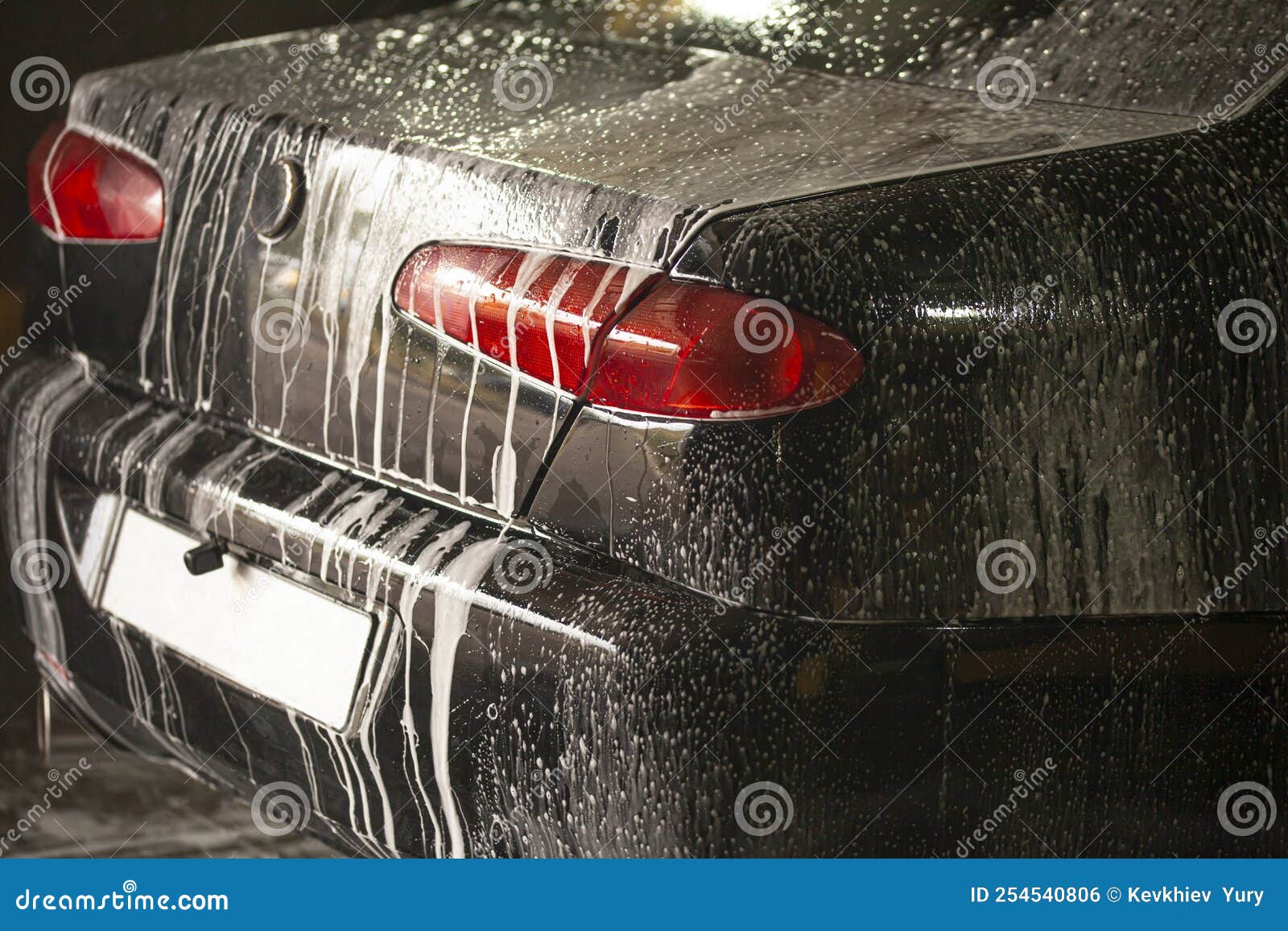 Car Wash at Service Station. Black Car in Foam. Car Getting a Wash with ...