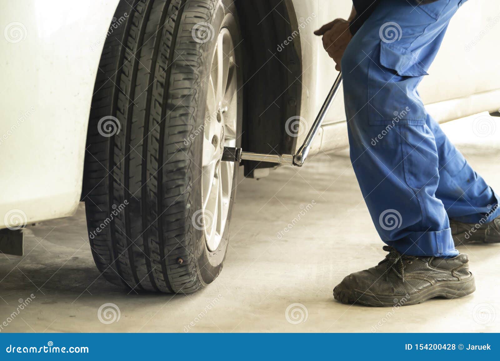 Mechanic Changing Car Wheel with Impact Wrench at Service Shop Stock ...