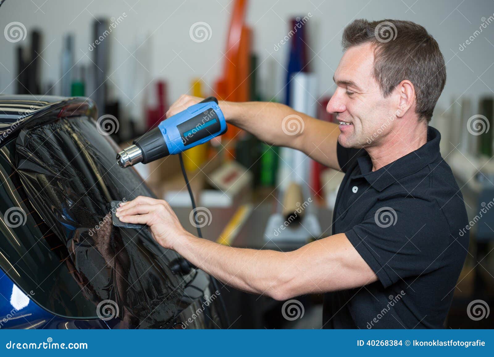 Car Wrapper Using Heat Gun and Squegee for Tinting Window Stock Photo ...