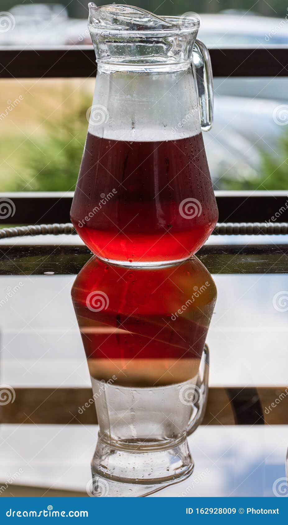 Carafe of Red Wine on a Reflective Surface - Outdoor Table Stock Image ...