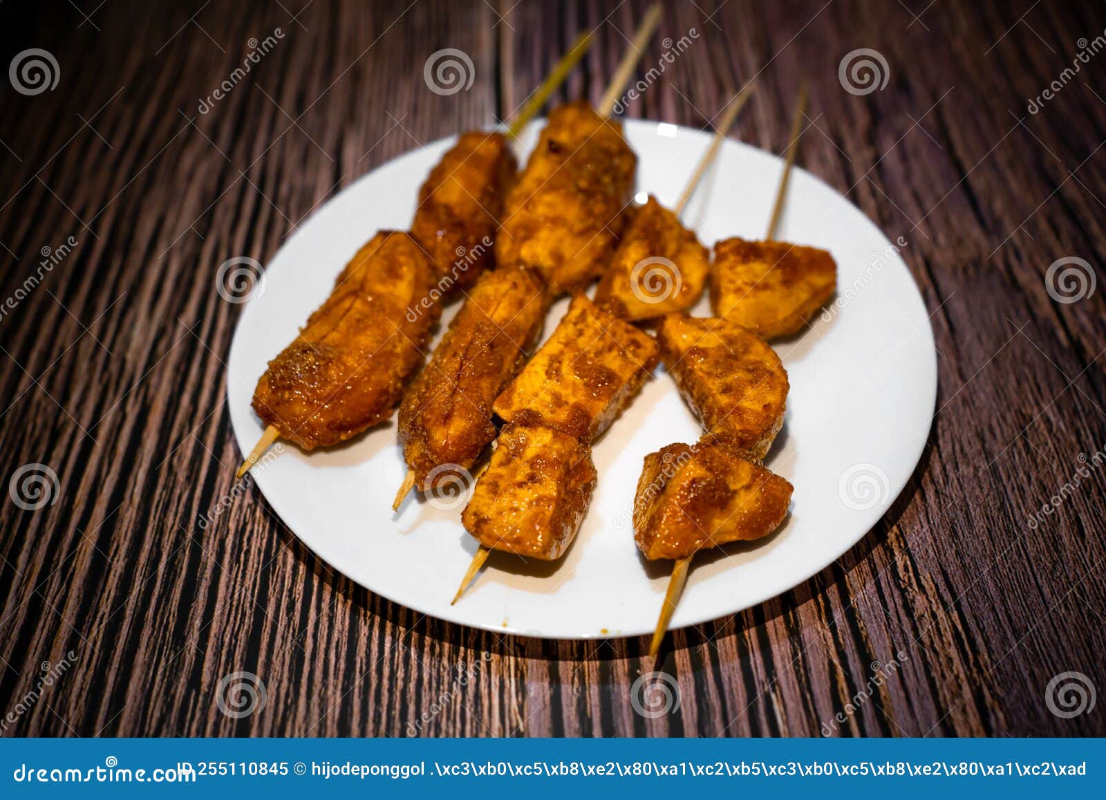 Caramelized Banana and Kamote Que in a Stick on White Plate Stock Image ...