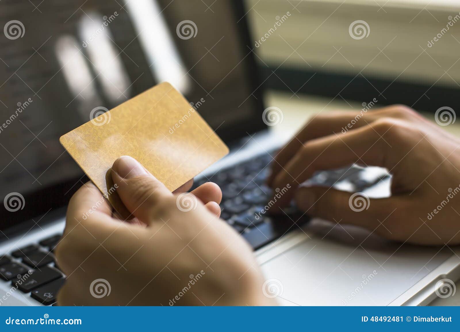 Card in Hand and Entering Security Code Using Laptop Keyboard. Stock ...