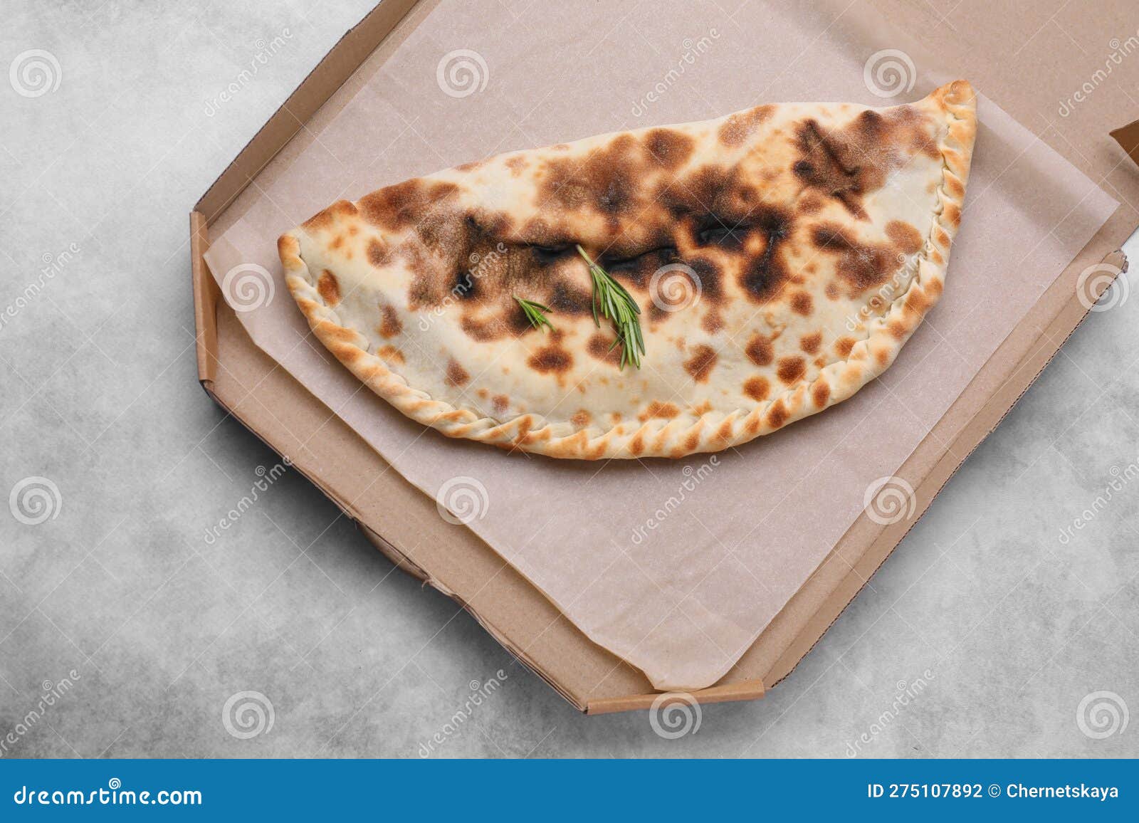 Cardboard Box with Delicious Calzone on Grey Table, Top View Stock ...