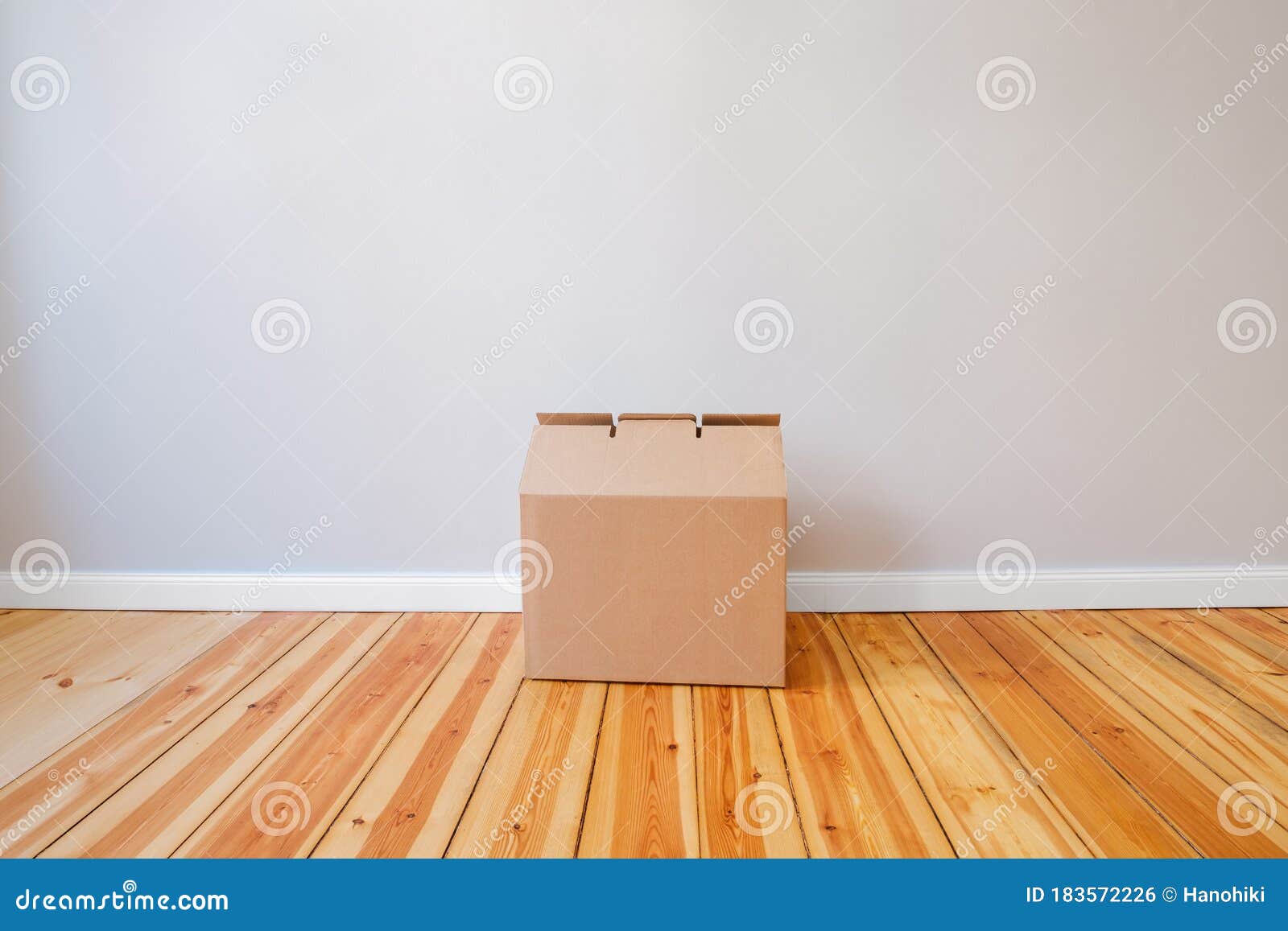Cardboard Box in Empty Room,on Wooden Floor in New Flat Stock Photo ...