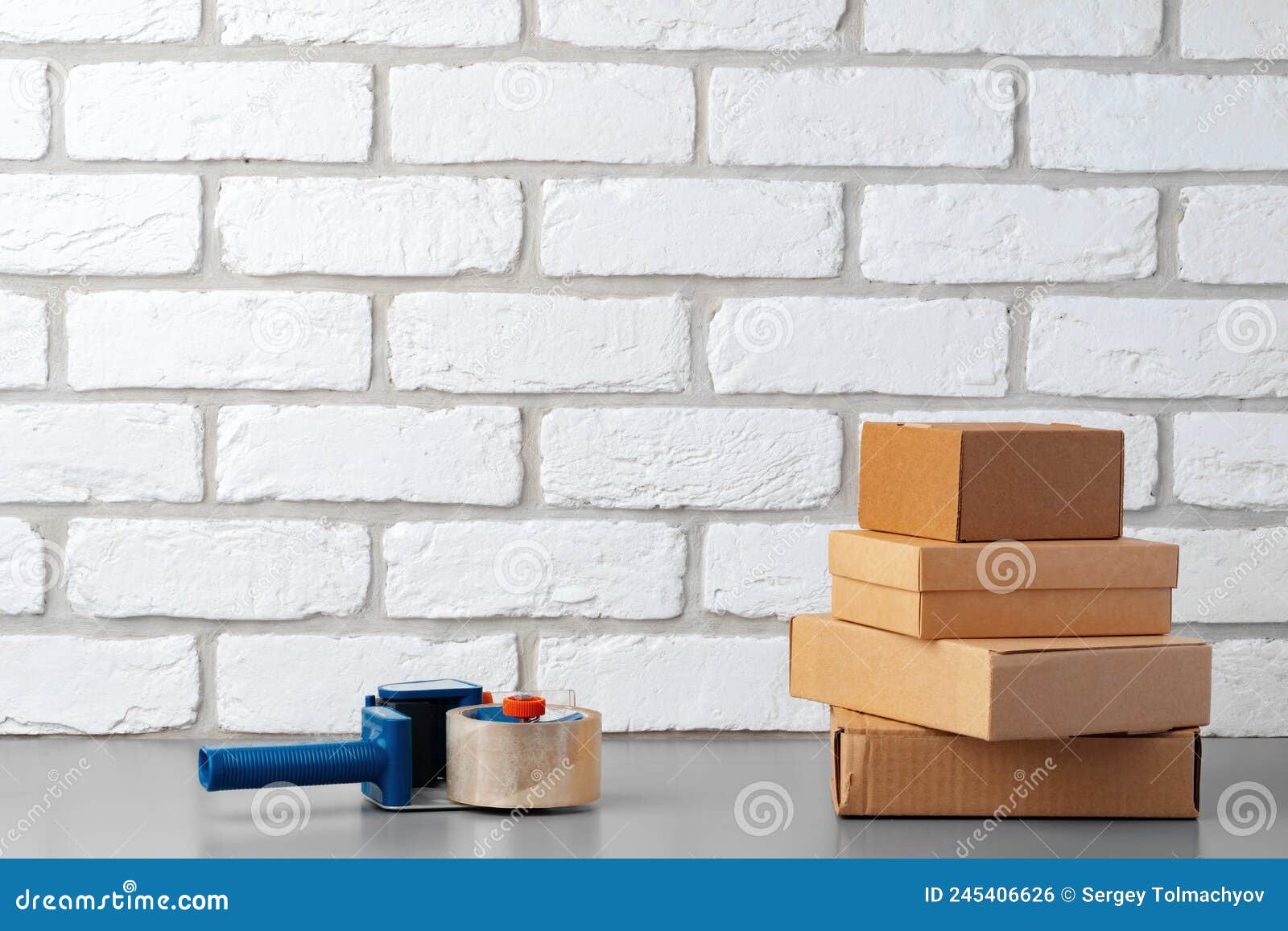 Cardboard Boxes Against White Brick Wall, Close Up Stock Photo - Image ...