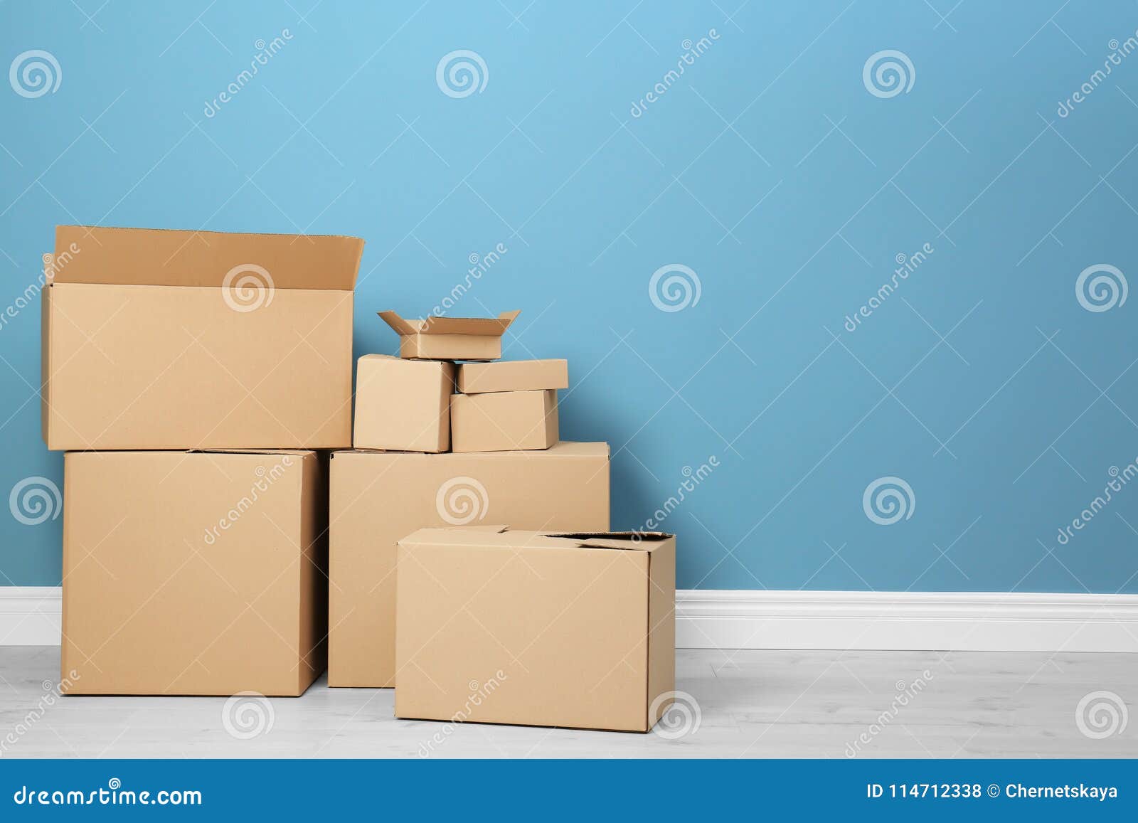 Cardboard boxes near wall stock photo. Image of send - 114712338