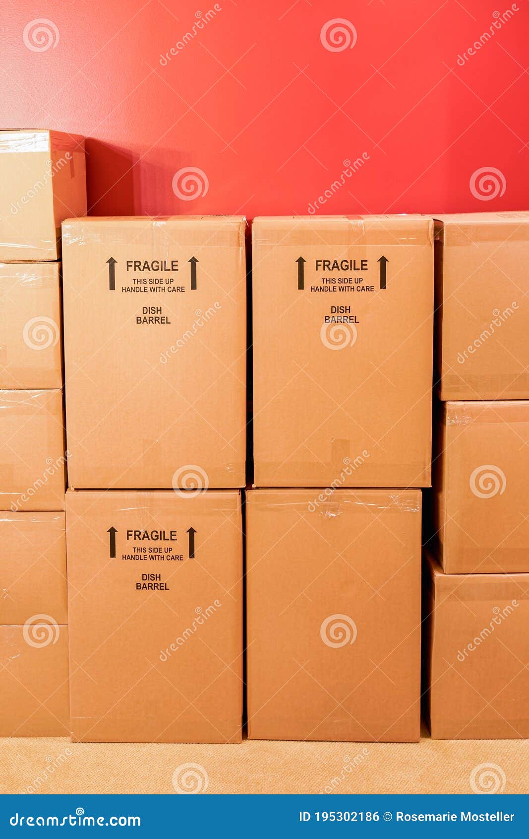 Cardboard Moving Boxes Stacked Up Against a Red Wall Stock Photo ...