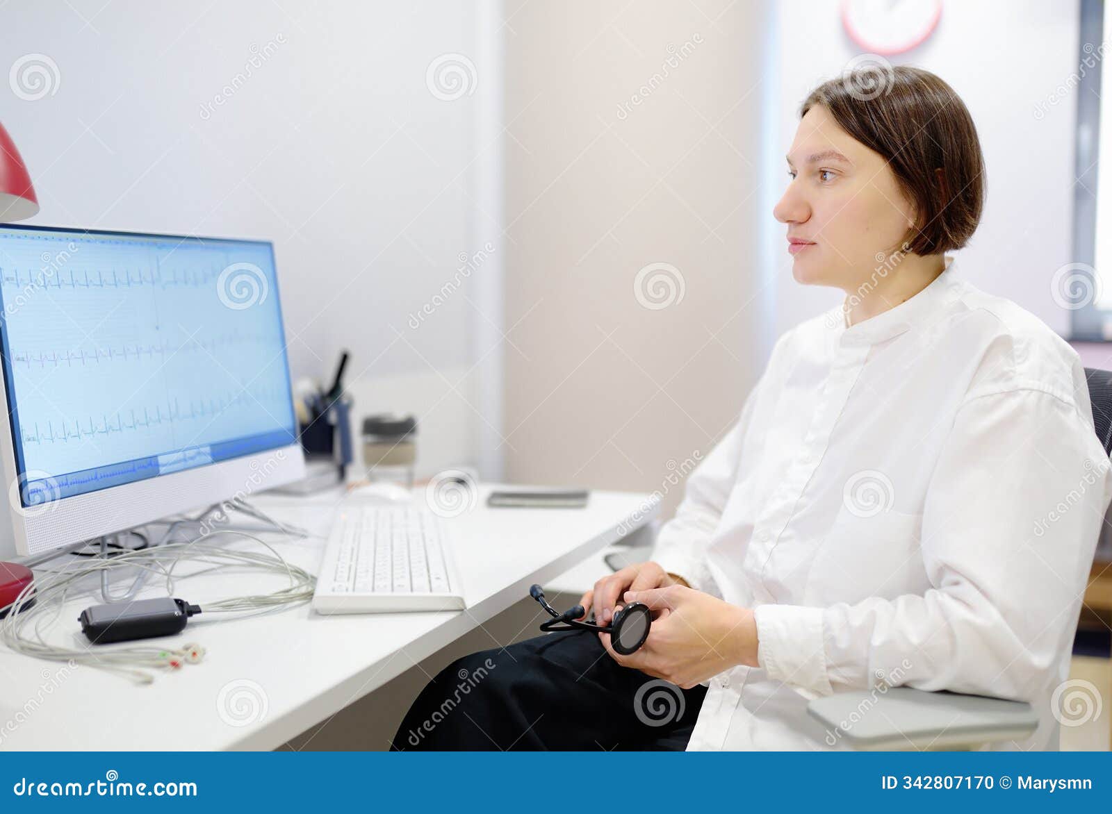 A Cardiologist during Appointment of Patient. Doctor Shows EKG on the ...