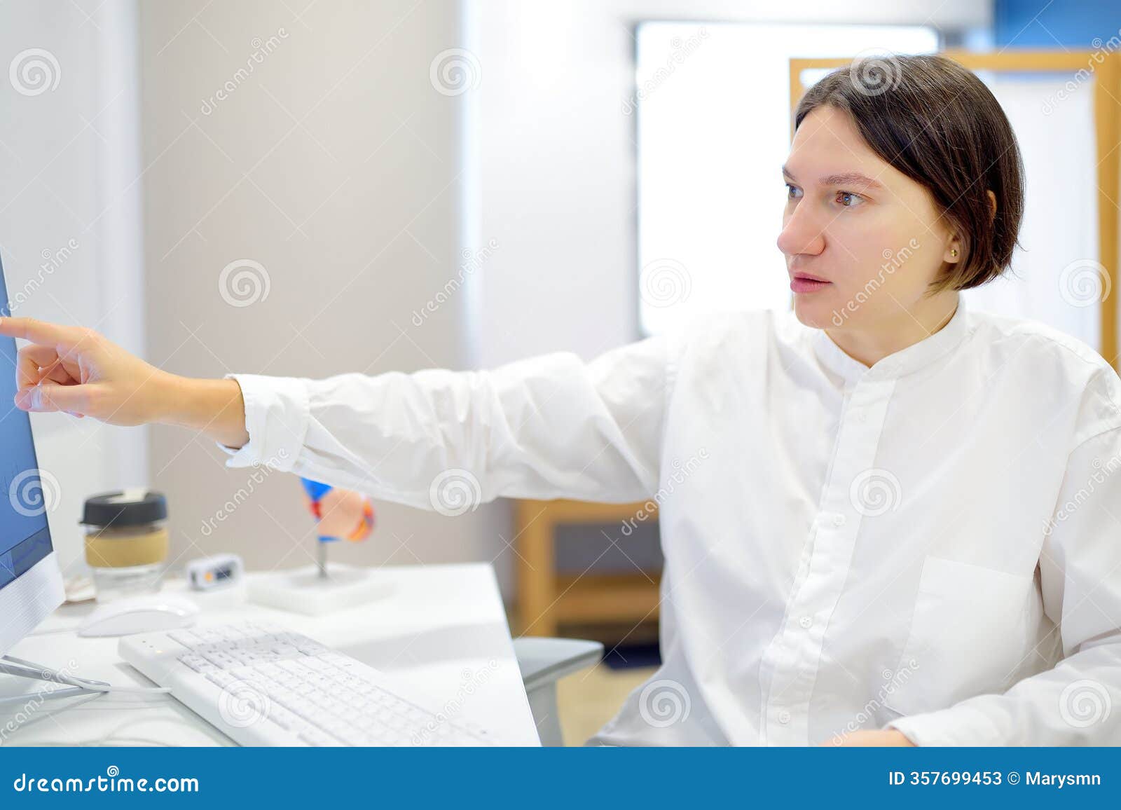 A Cardiologist during Appointment of Patient. Doctor Shows EKG on the ...