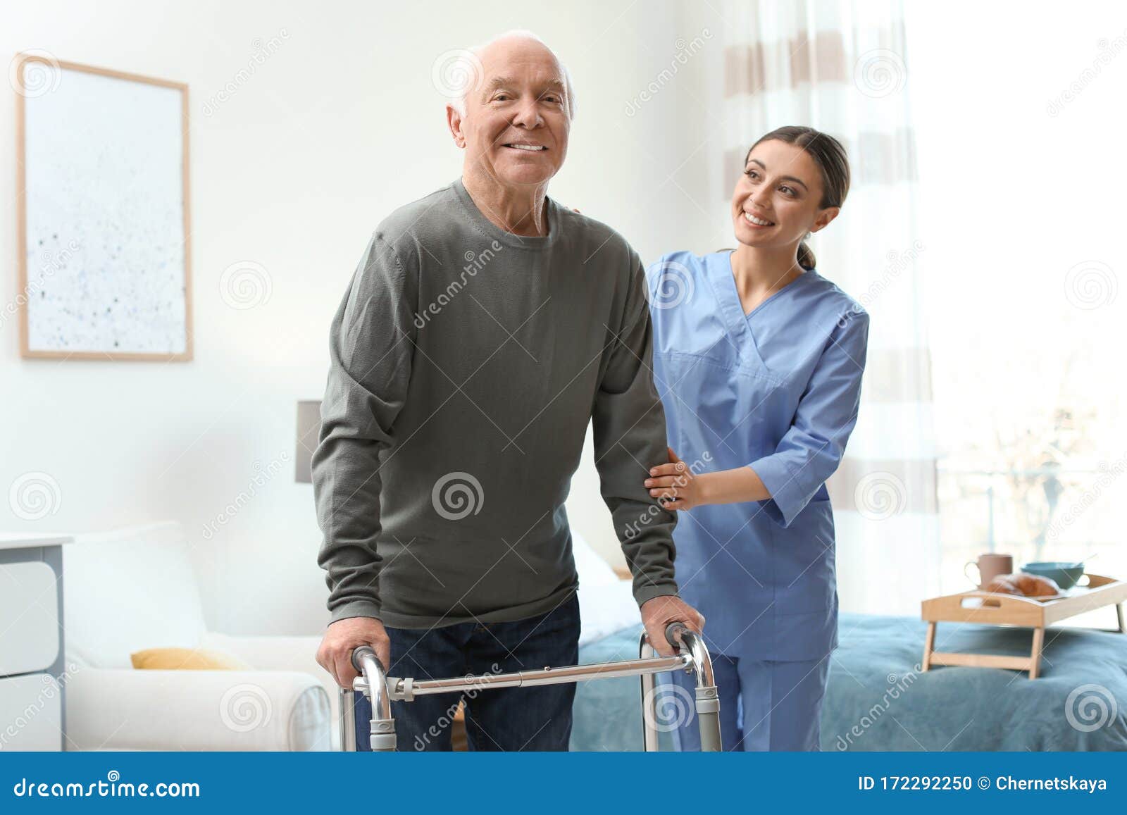 Care Worker Helping Elderly Man with Walker in Hospice Stock Photo ...