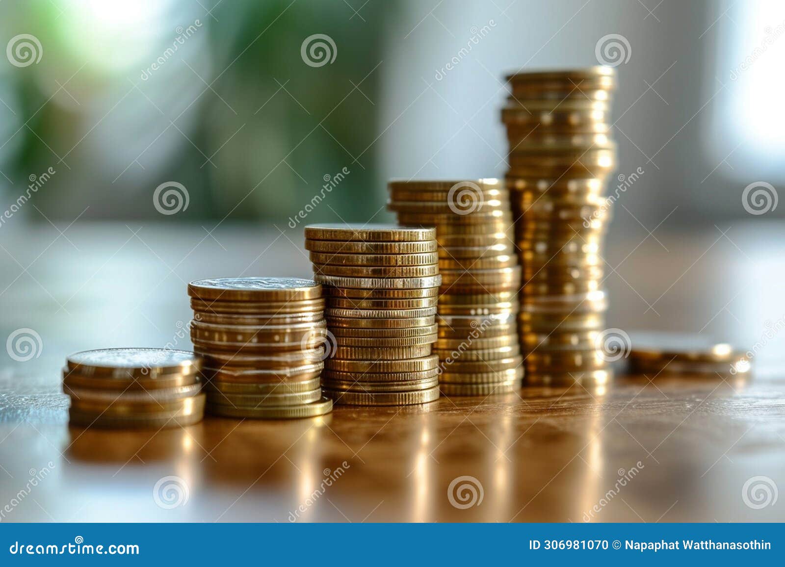 A Carefully Balanced Stack of Coins Representing Savings and Financial ...