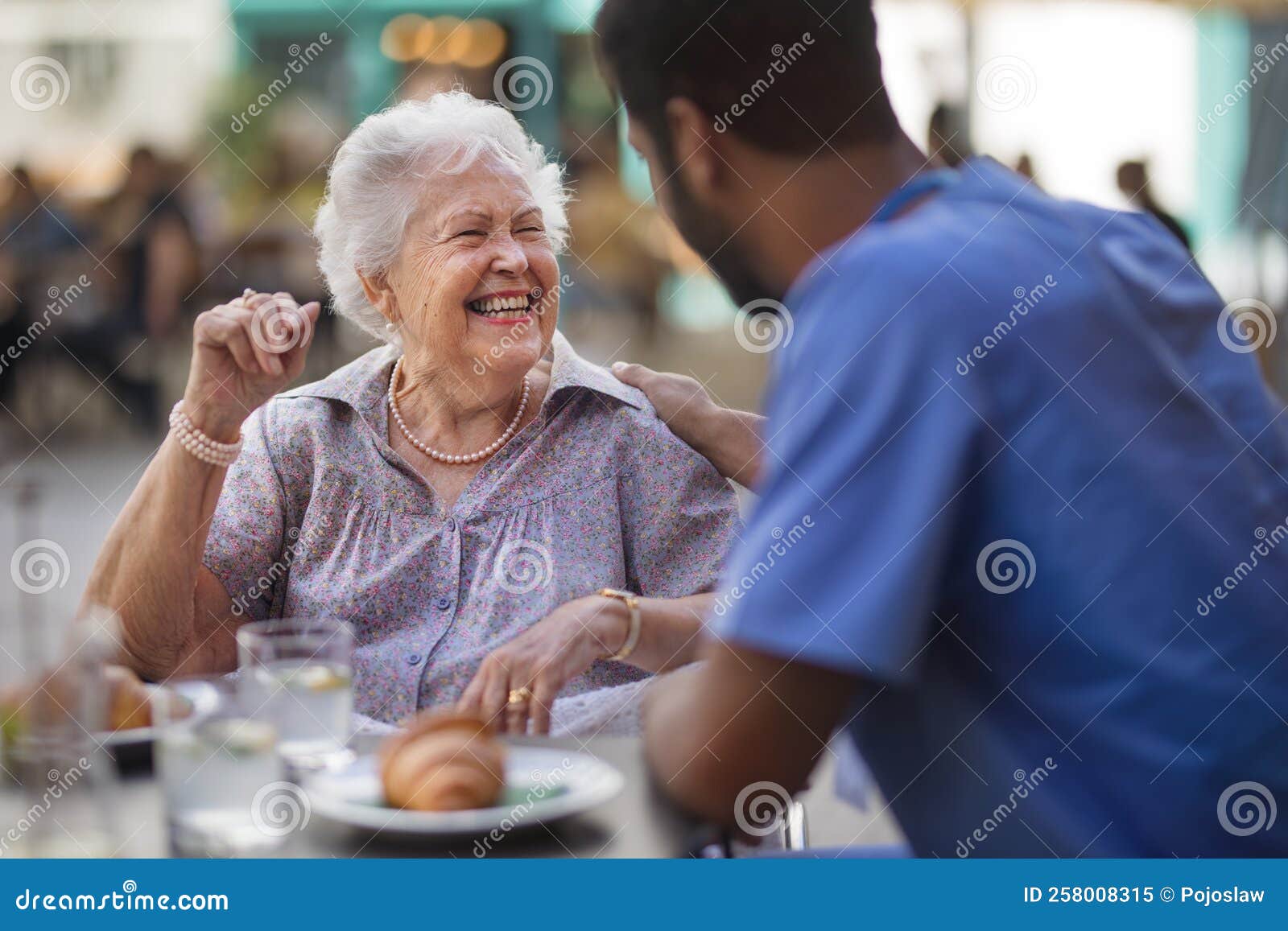 Caregiver Having Breakfast with His Client at Cafe. Stock Image - Image ...