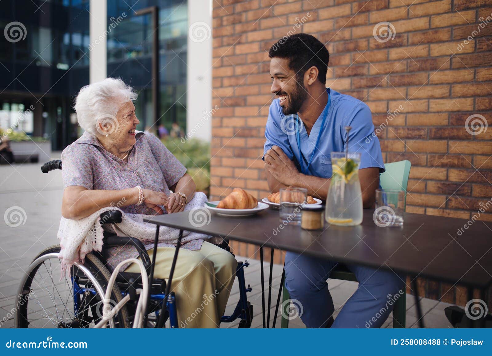 Caregiver Having Breakfast with His Client at Cafe. Stock Photo - Image ...