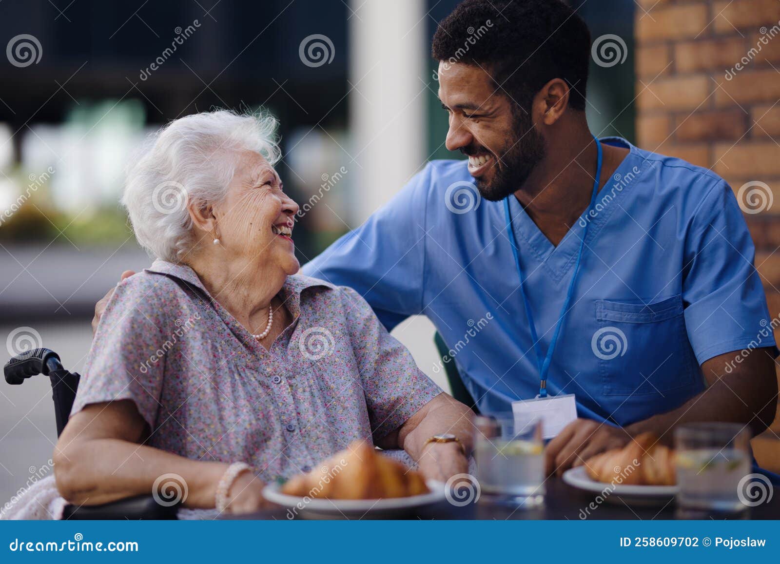 Caregiver Having Breakfast with His Client at Cafe. Stock Photo - Image ...