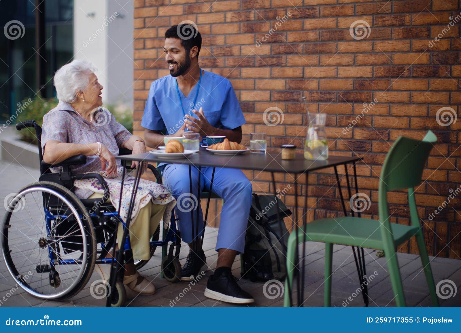 Caregiver Having Breakfast with His Client at Cafe. Stock Image - Image ...