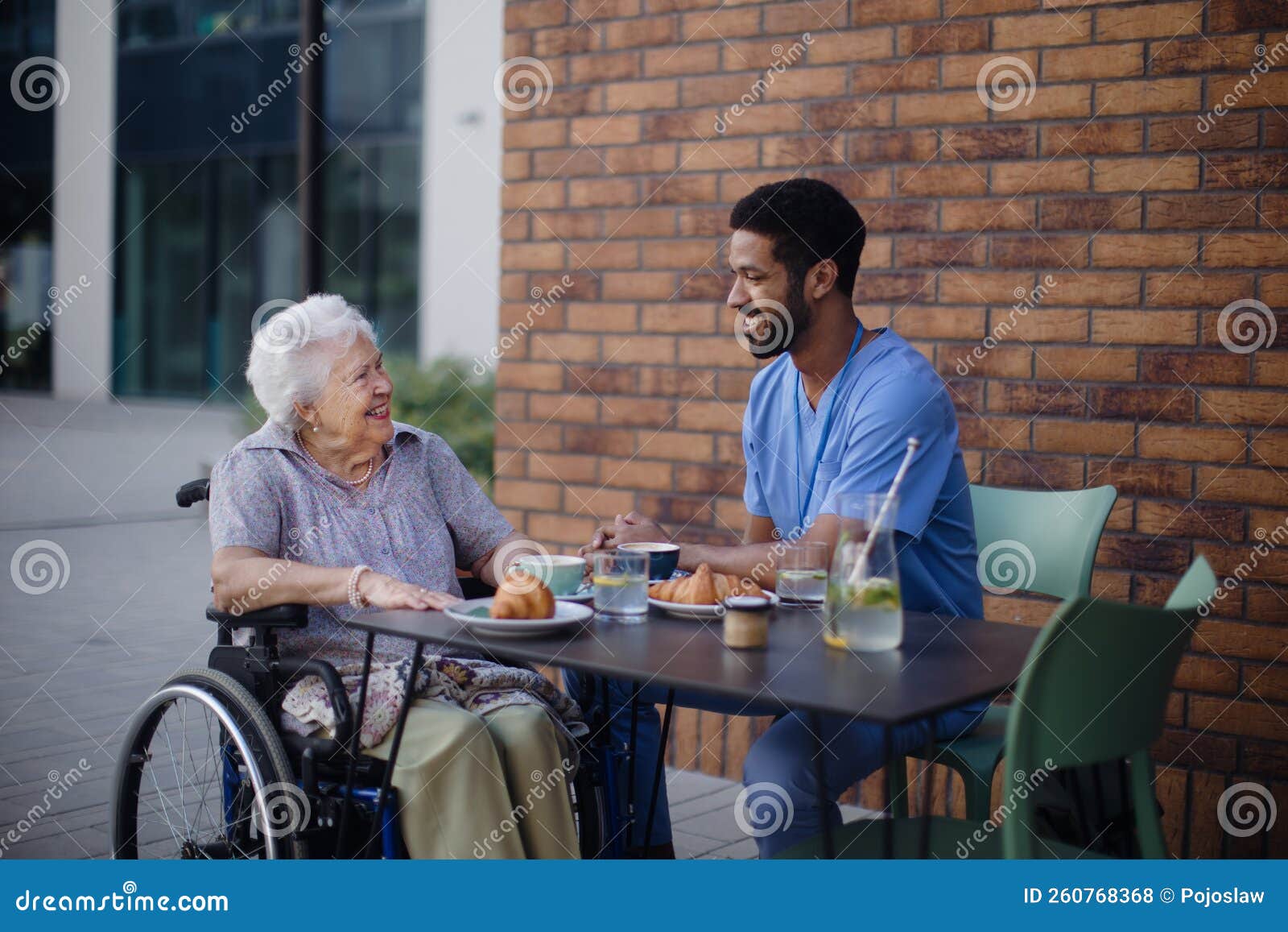Caregiver Having Breakfast with His Client at Cafe. Stock Photo - Image ...