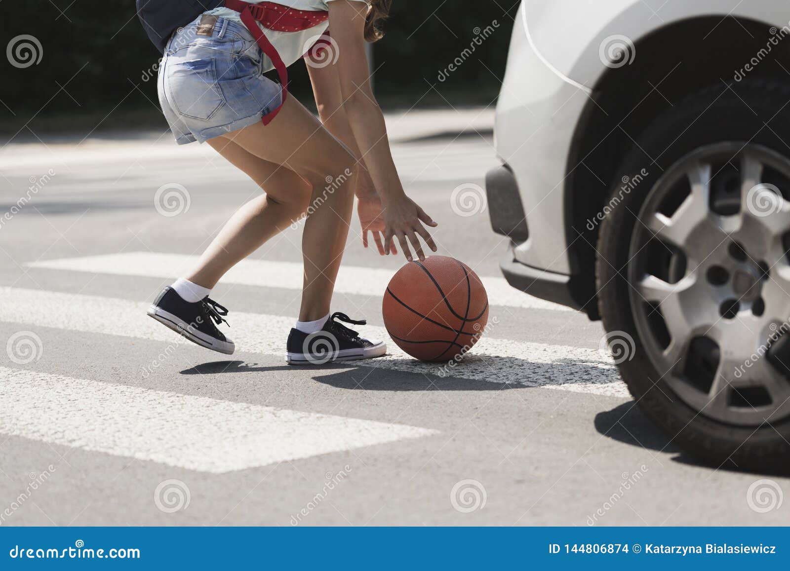 Kid Holding a Ball on the Crosswalk in Front of a Car Stock Photo ...