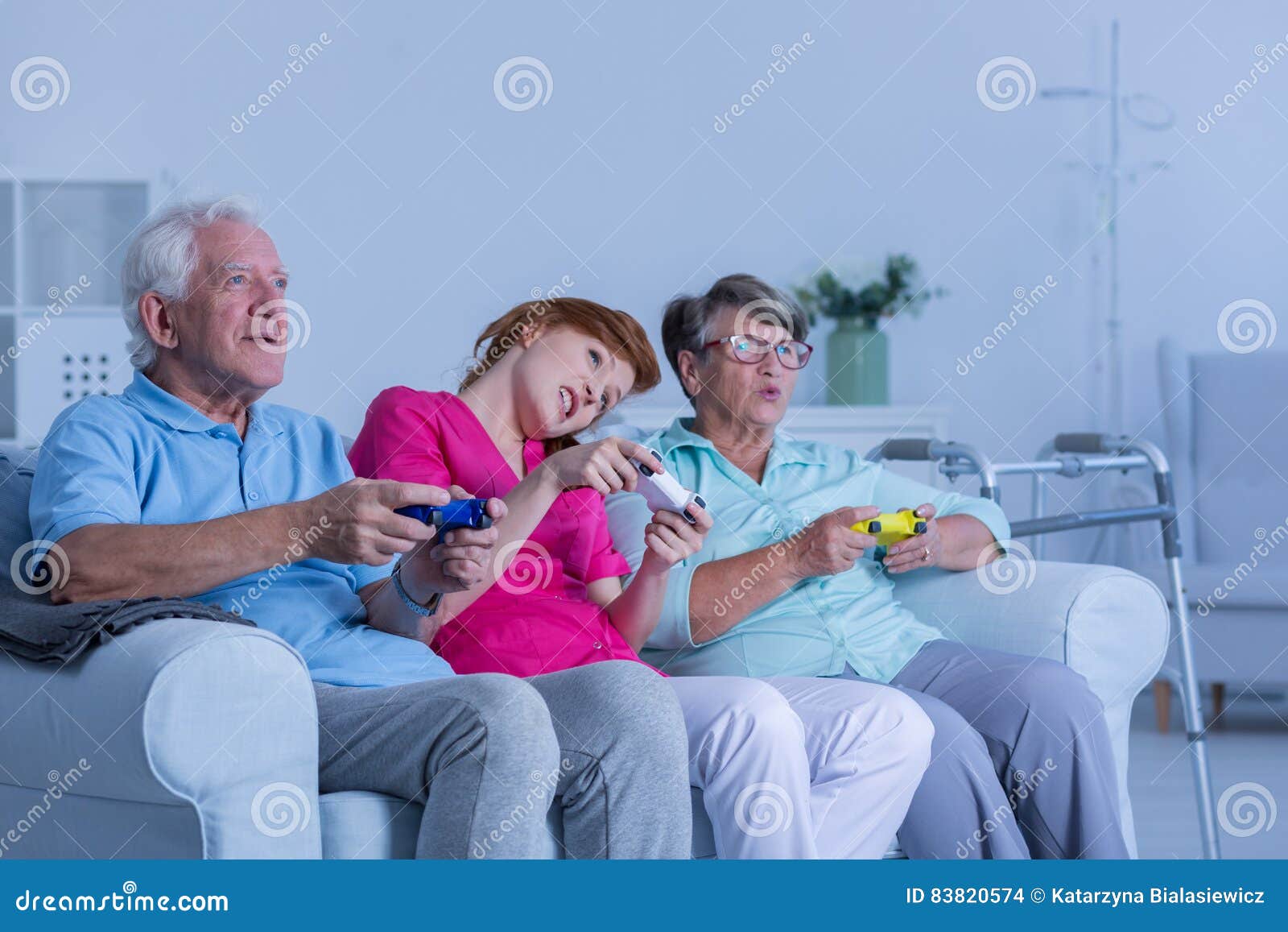 Carer Playing Video Games with Elderly Couple Stock Photo - Image of ...