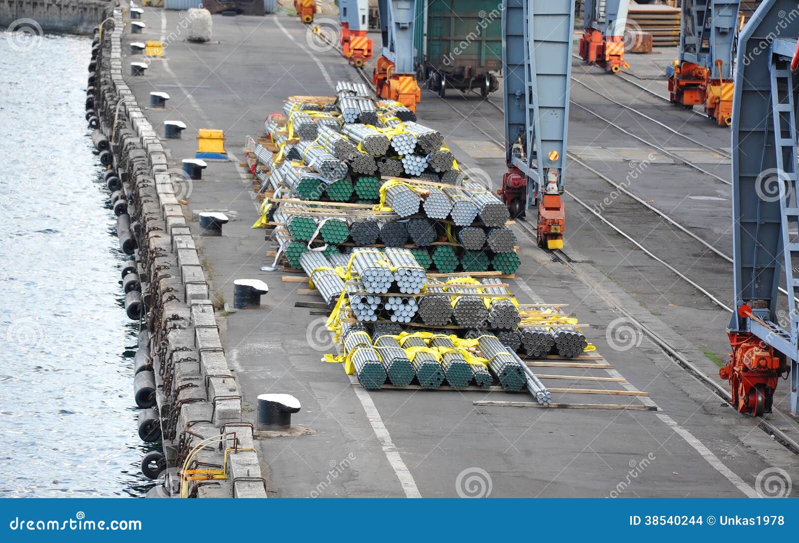 Cargo crane and pipe stack stock photo. Image of pipe - 38540244
